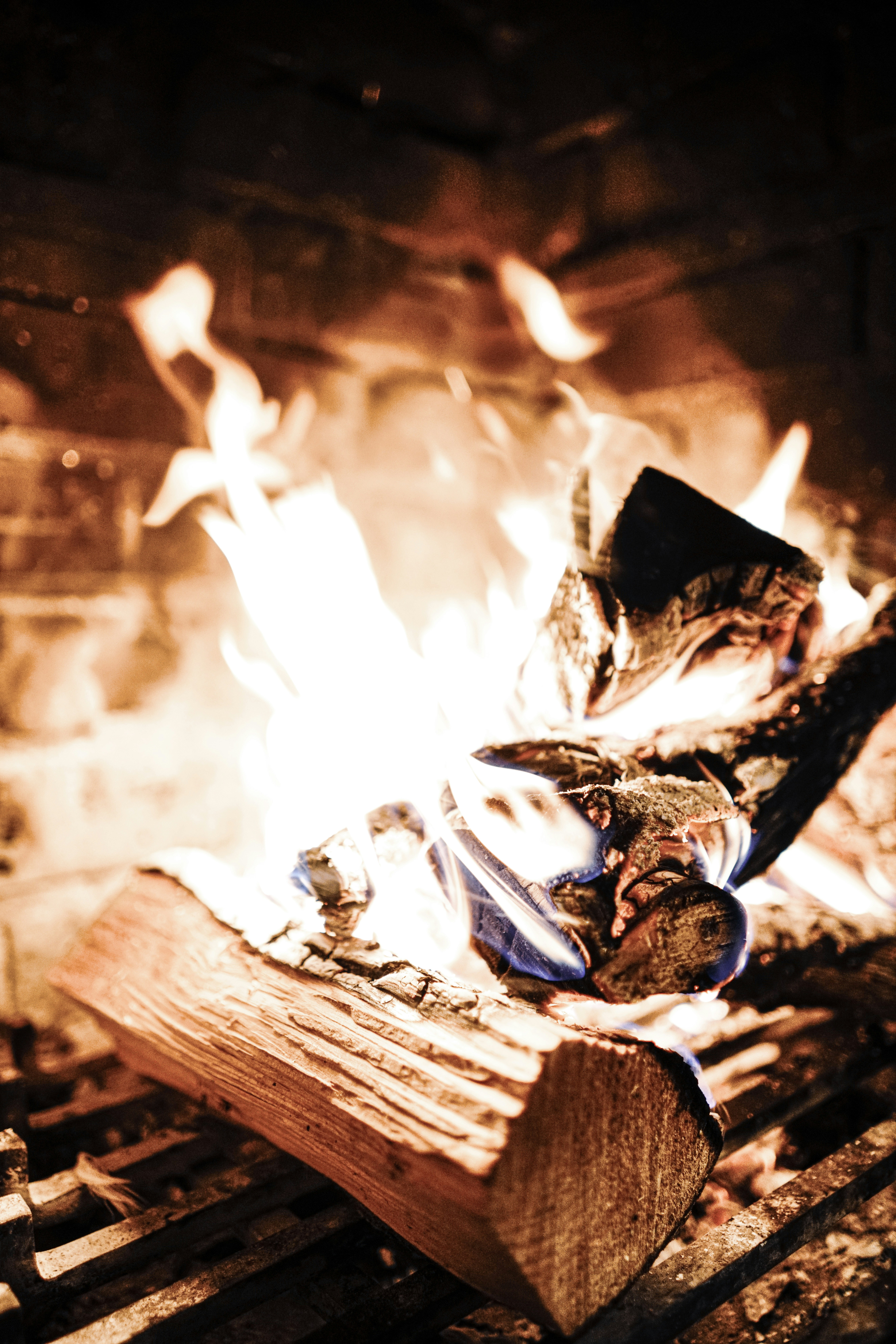 Ember Core: Close-Up of Fire-Kissed Logs in a Brick Fireplace