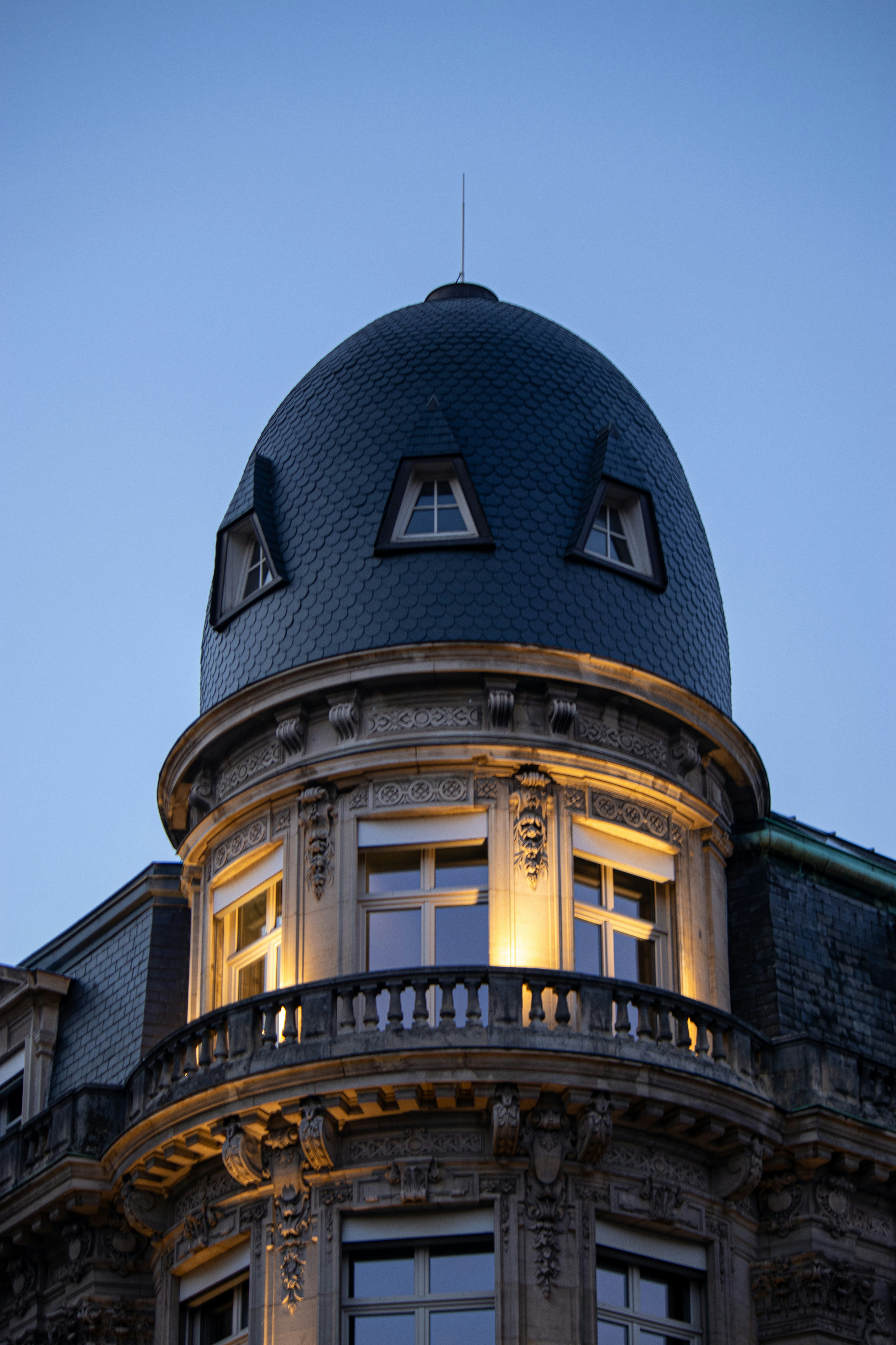 Azure-Domed Turret: Ornate Mansion Crowned by Blue Hour Light