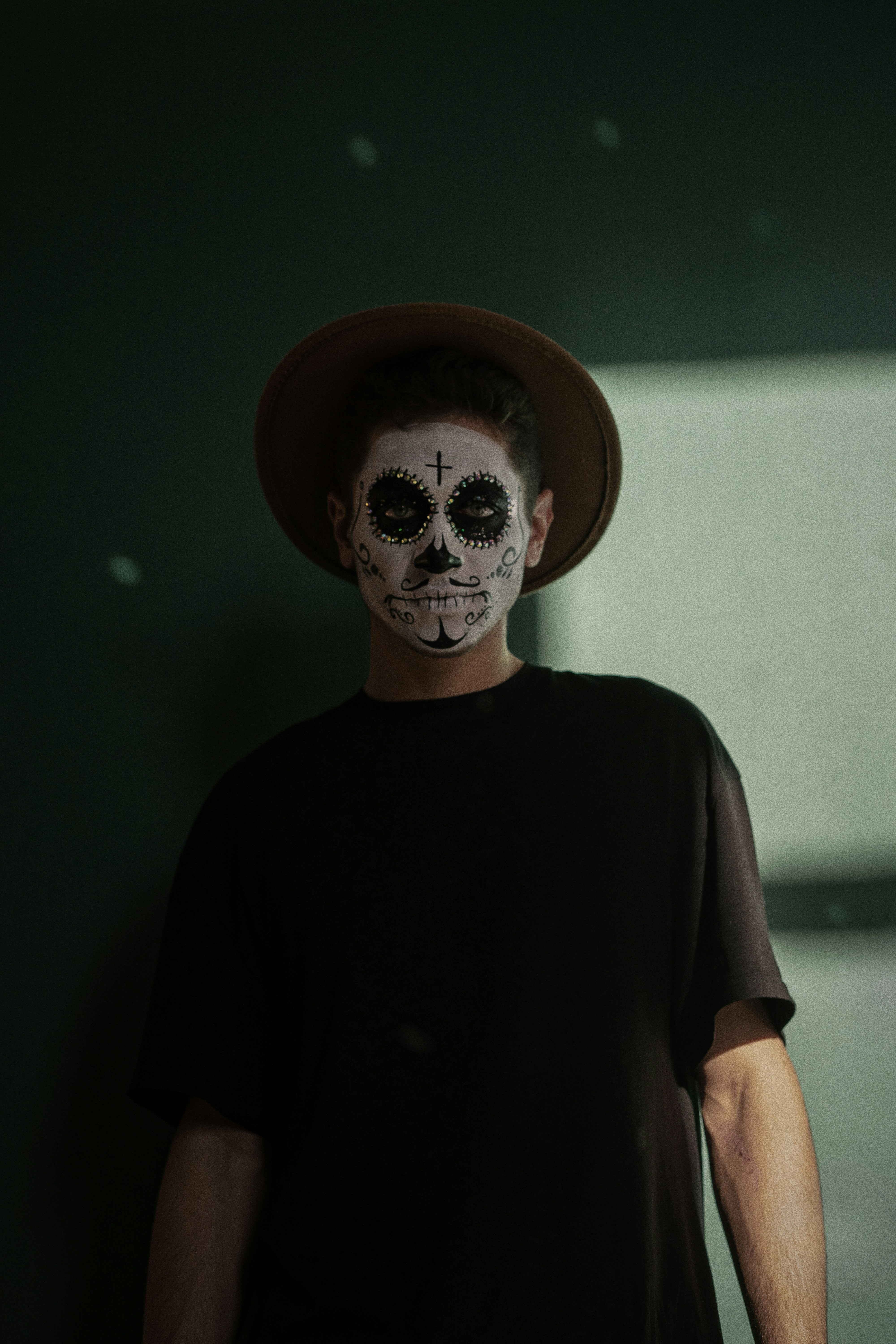 A man with a skull face painted on his face photo – Free Grey Image on ...