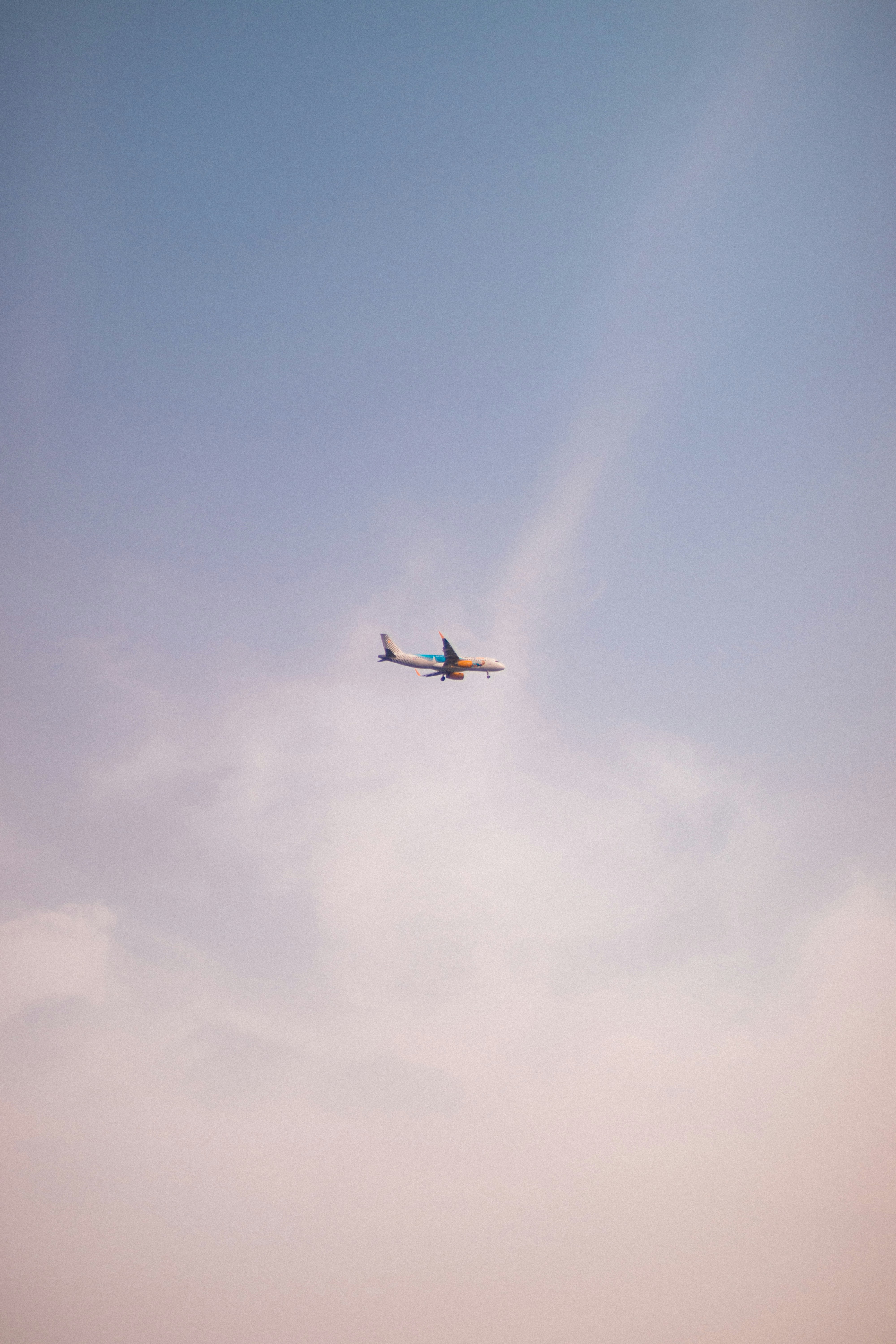 an airplane is flying in the sky above a beach