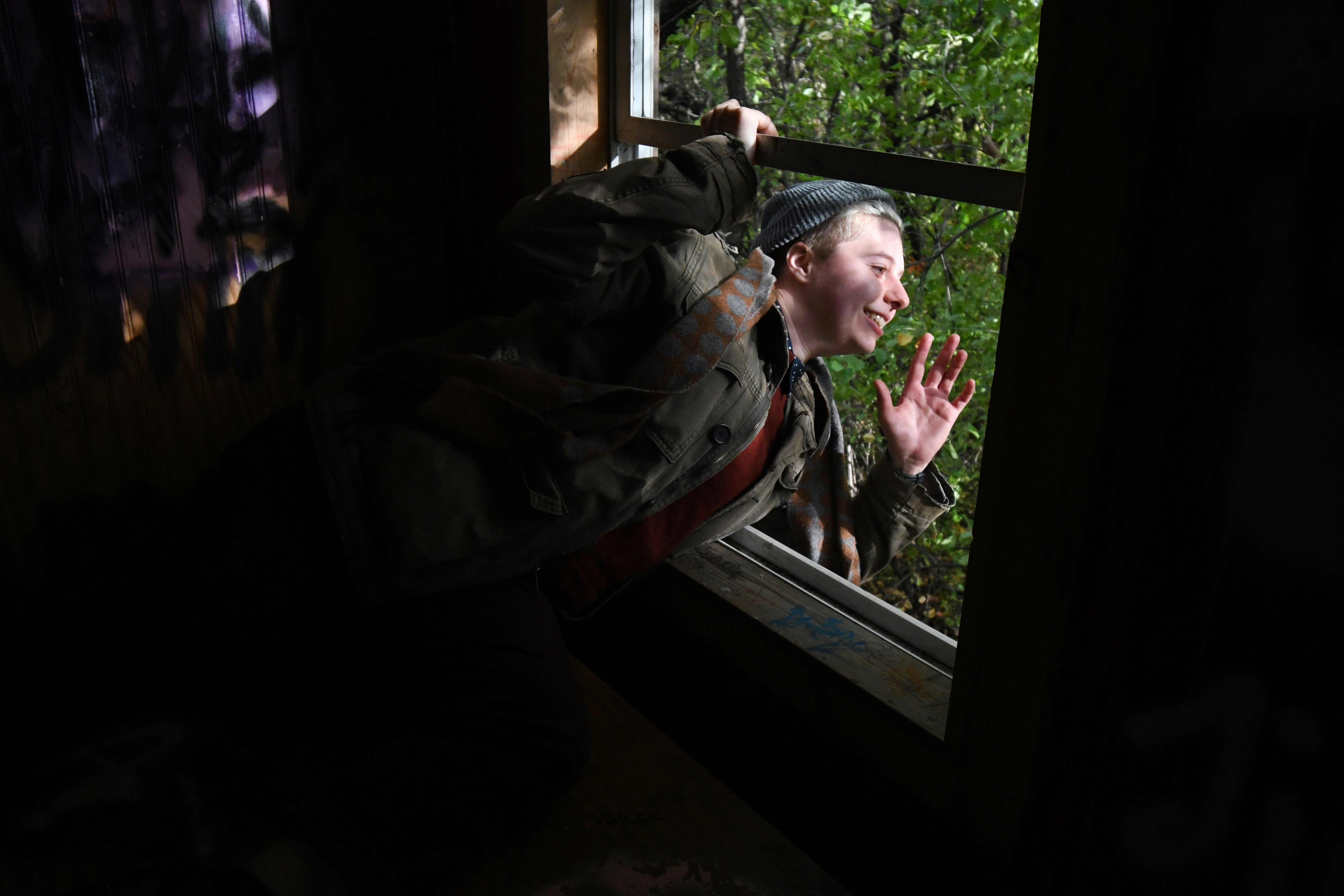 A man looking out a window at a forest photo – Free Shafer Image on ...