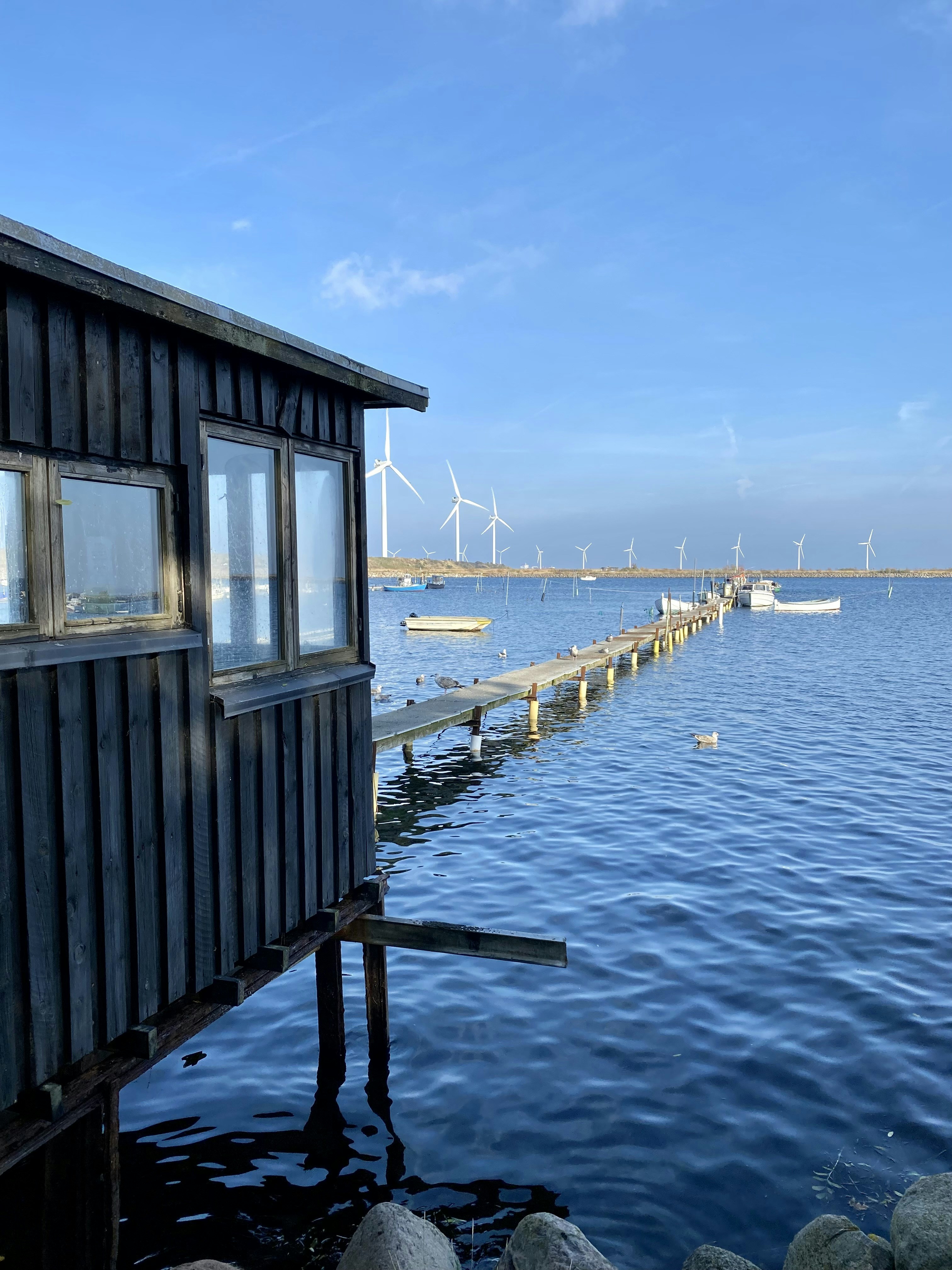 a boat is docked at the end of a pier