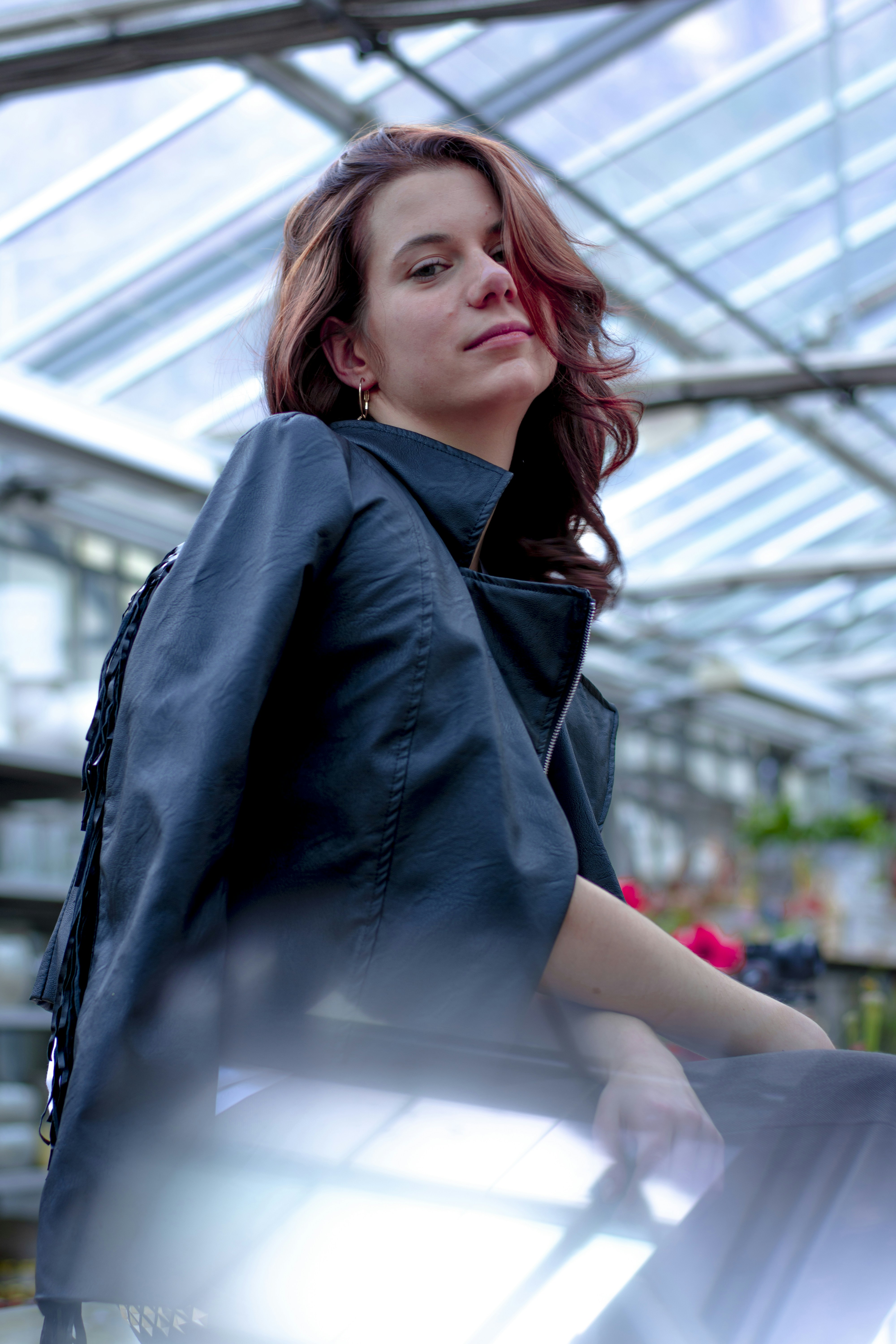 Portrait in Glasshouse: A Confident Gaze Under Soft Cathedral Light