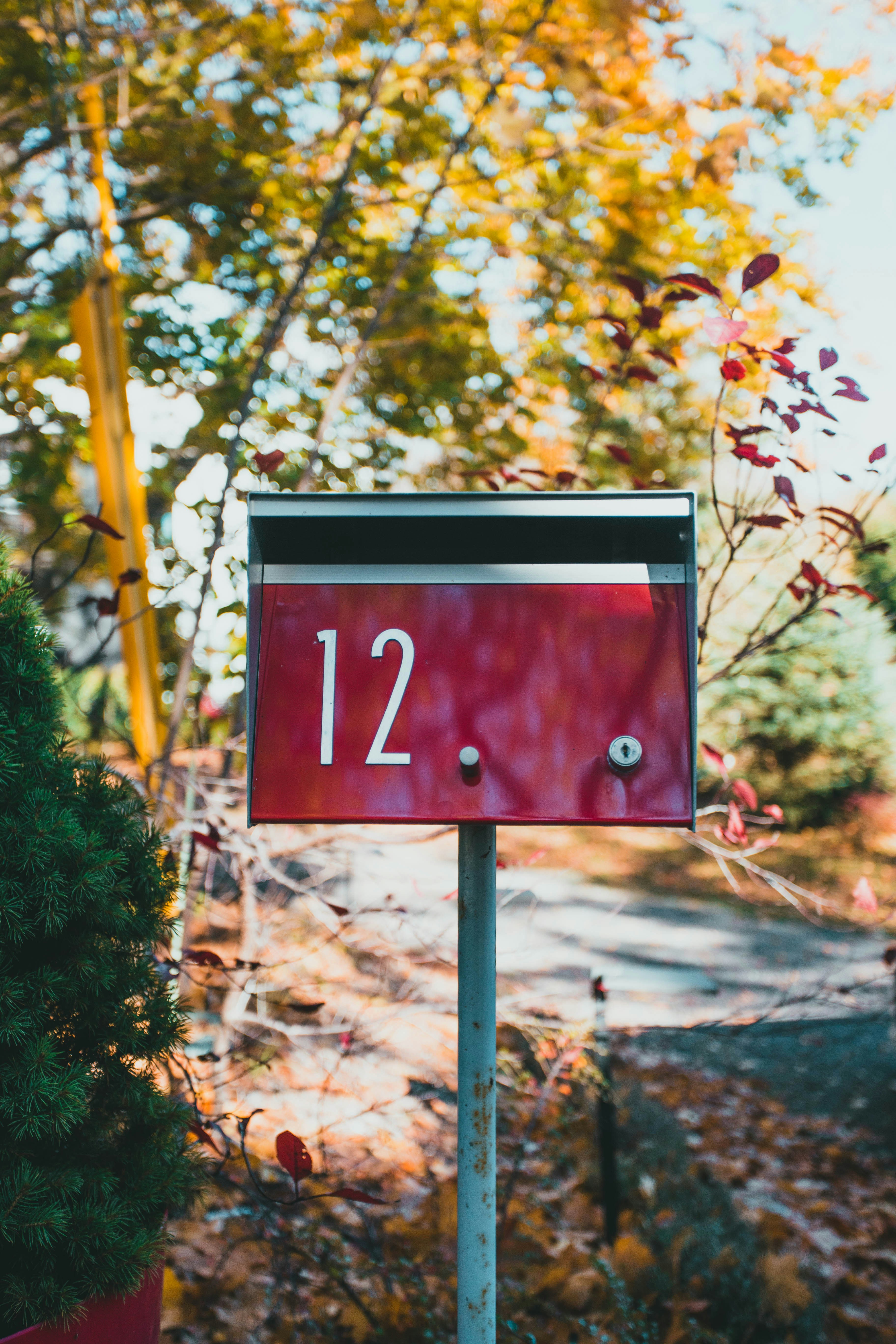 A red mailbox with the number twelve on it photo – Free Brown Image on ...