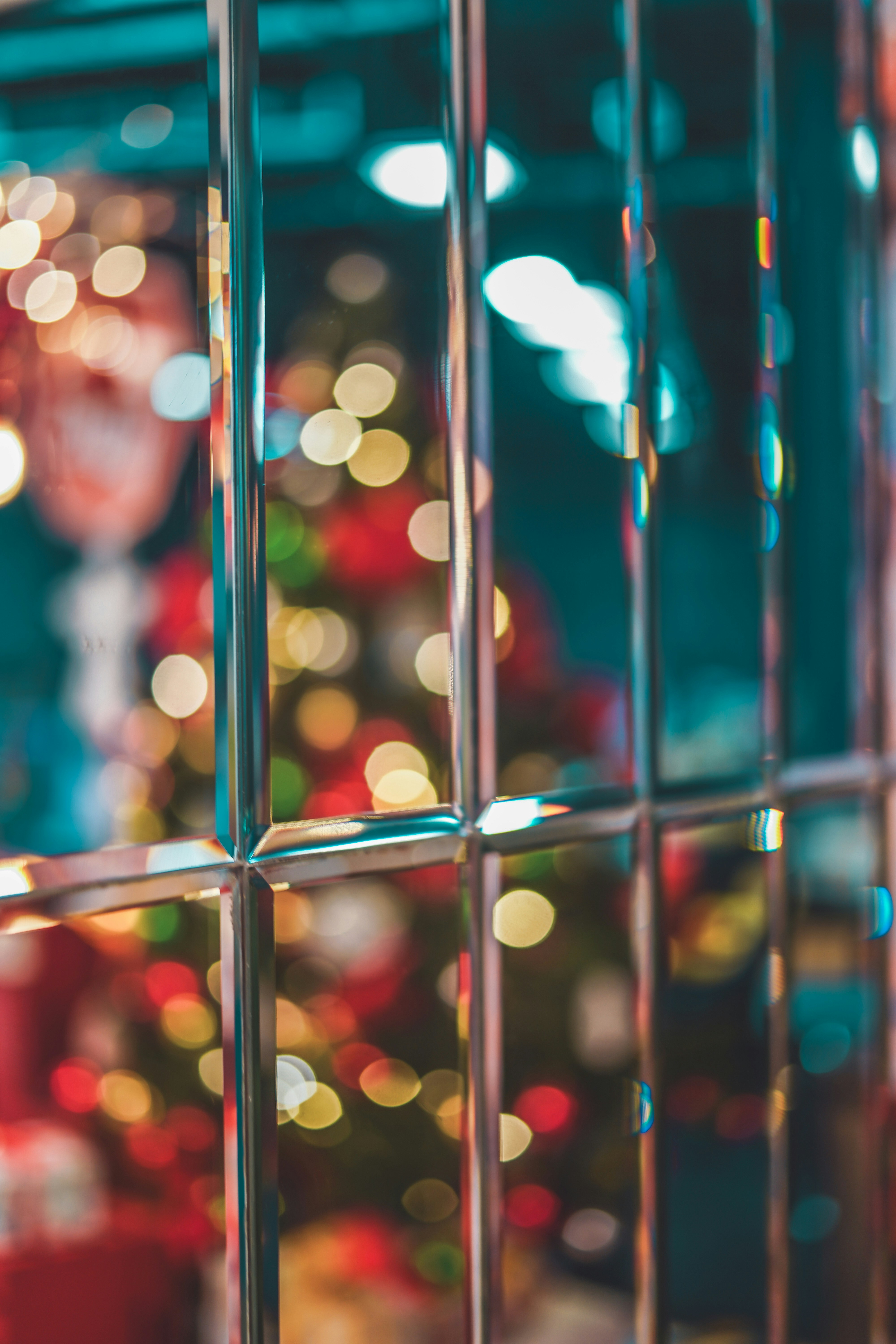 Chromed Grid Reflections: Neon Bokeh Through Shimmering Bars