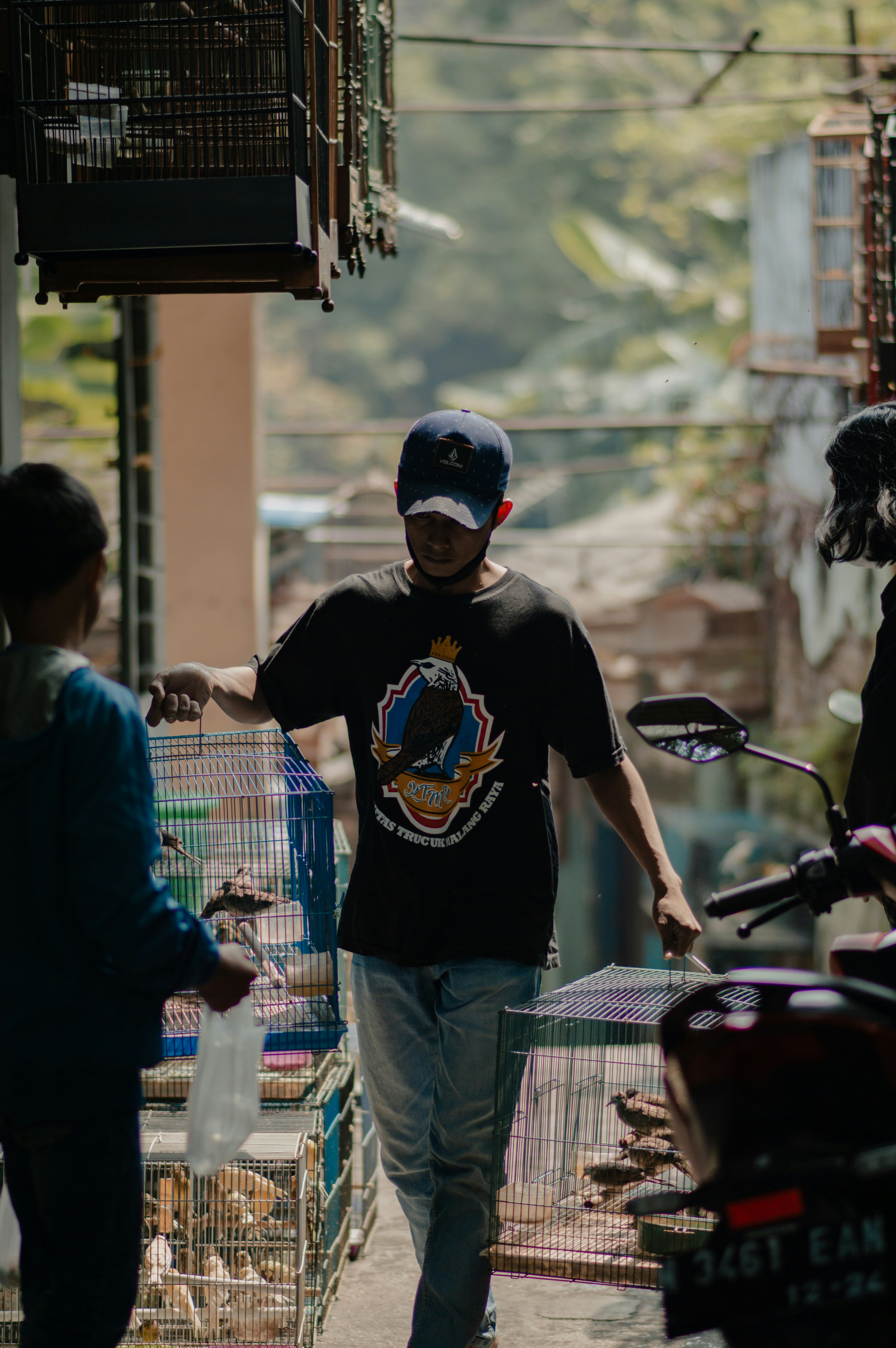 Midfield Dominance: Man in Cap Guides a Busy Pet Market Corridor