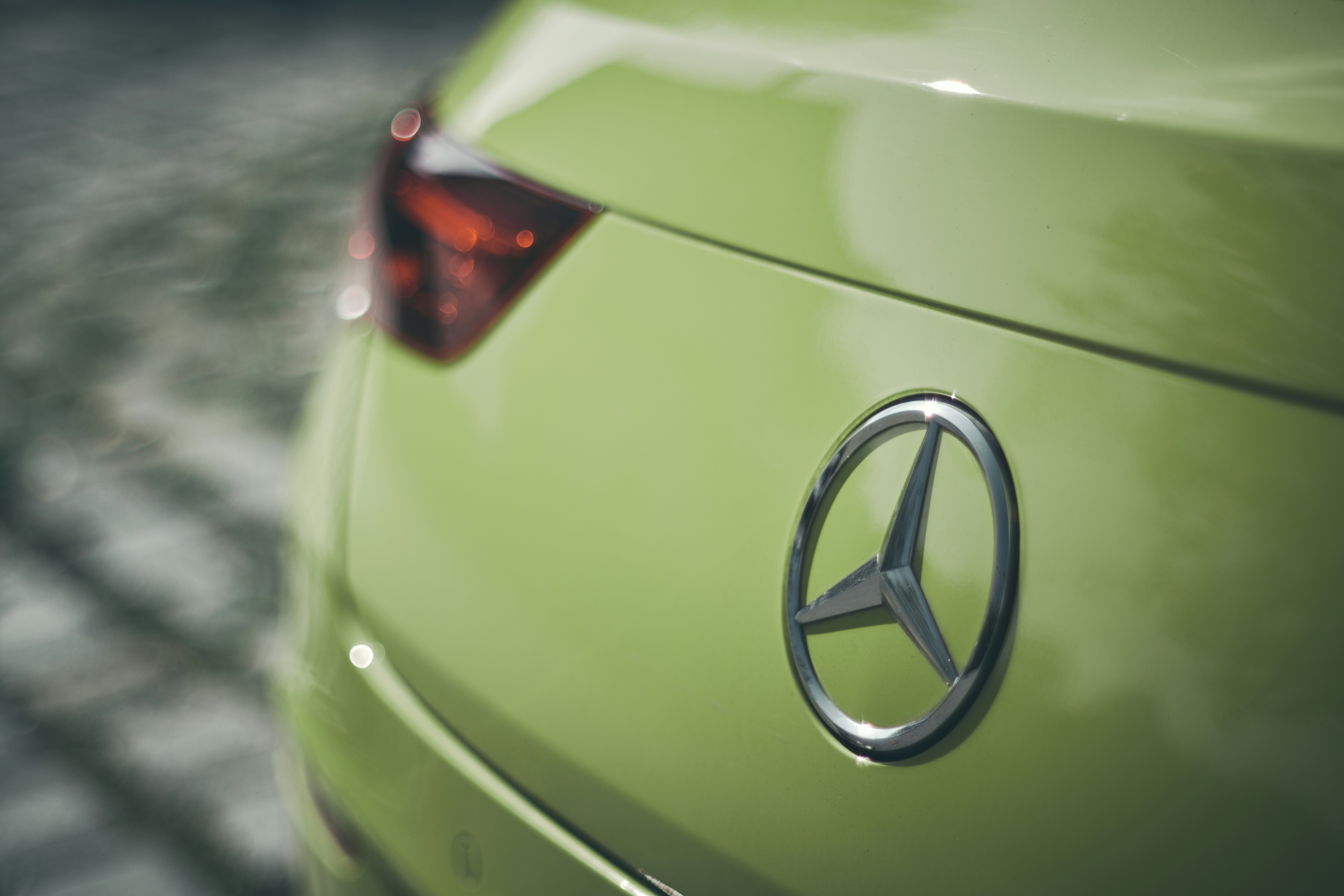 A close up of a mercedes logo on a green car photo – Free Yellow Image ...