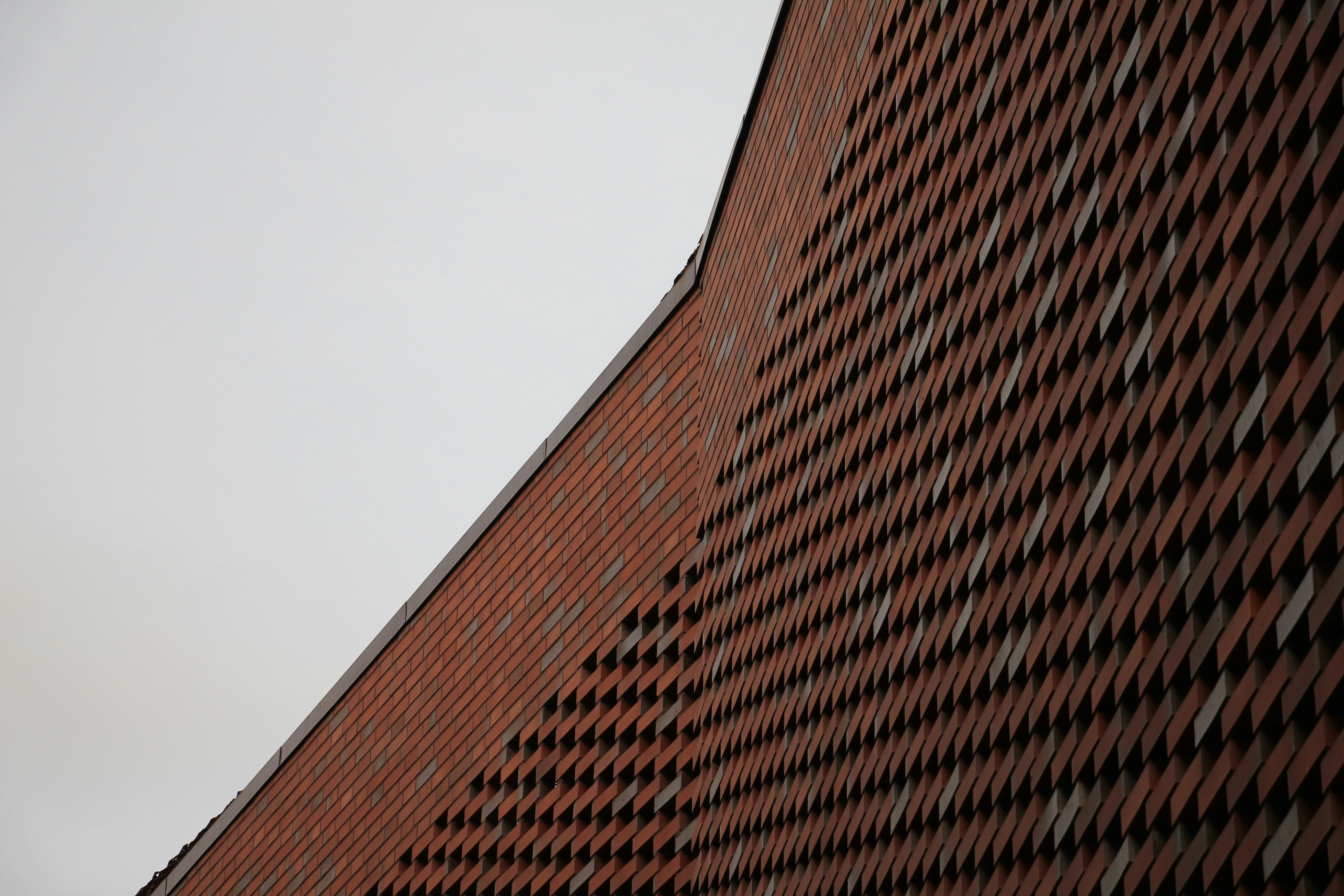 a red brick building with a clock on it's side