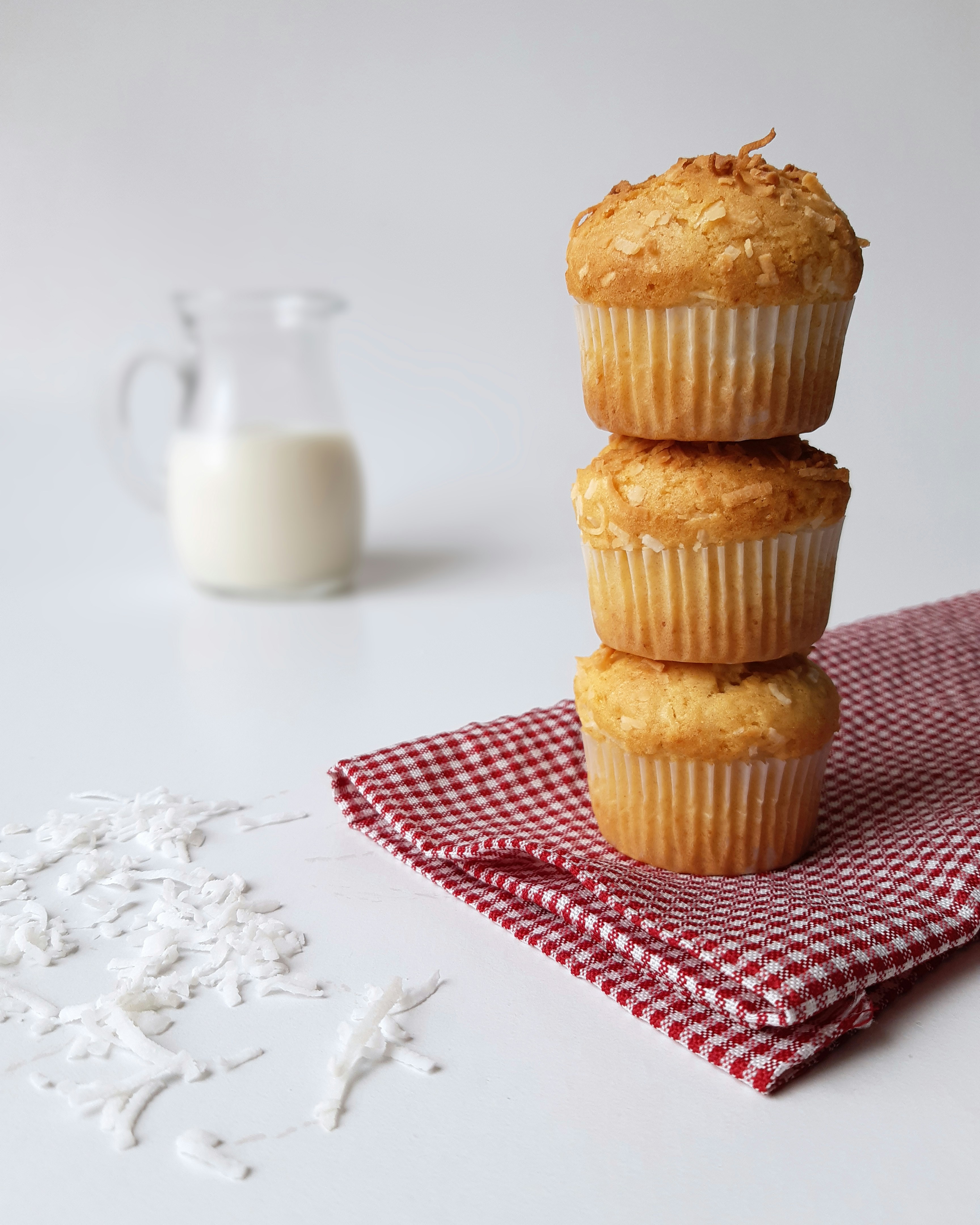 A stack of three muffins sitting on top of a red and white napkin photo ...