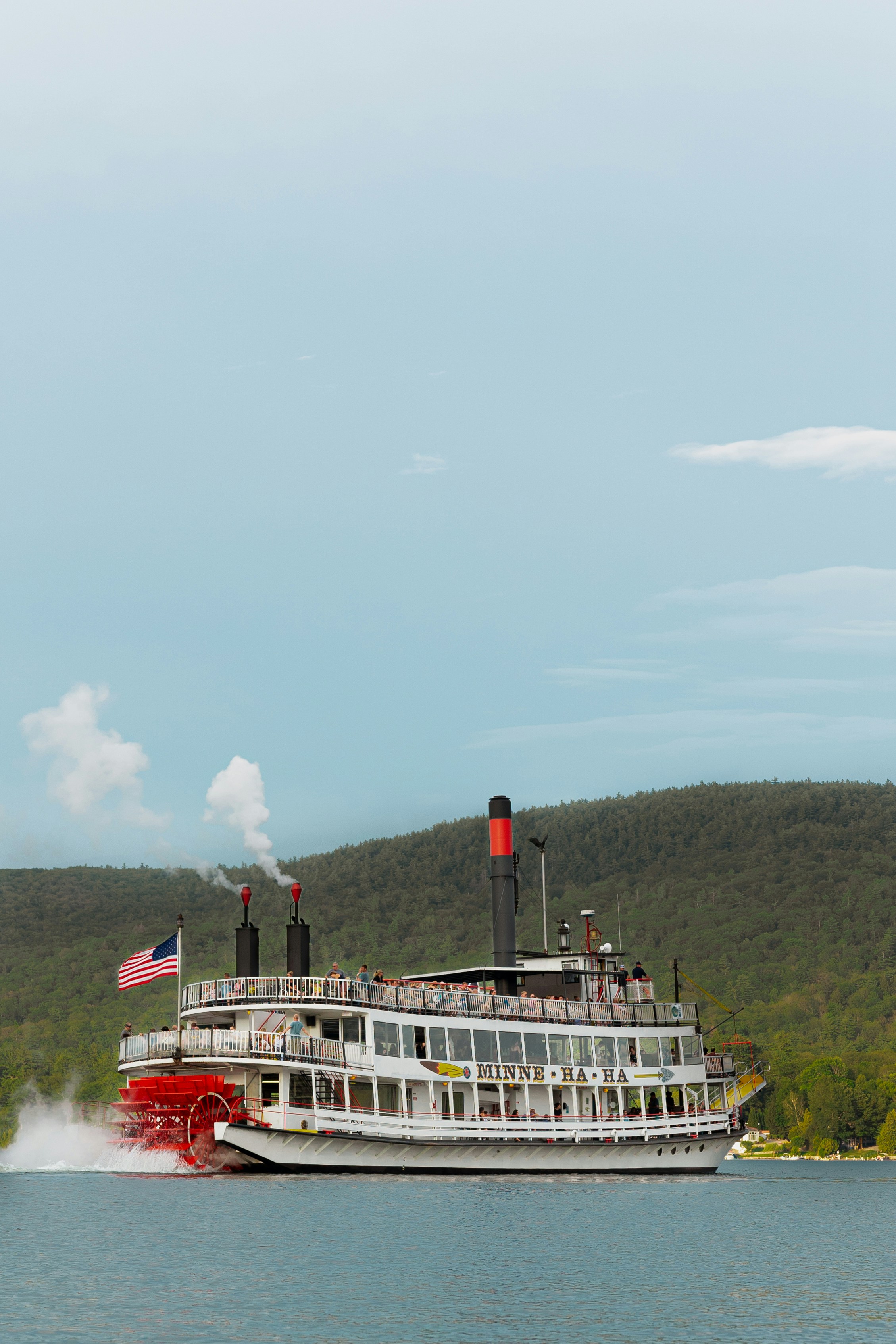 Minne-Ha-Ha Steamer Gliding Over a Tranquil Lake Beneath Pine-Draped Hills