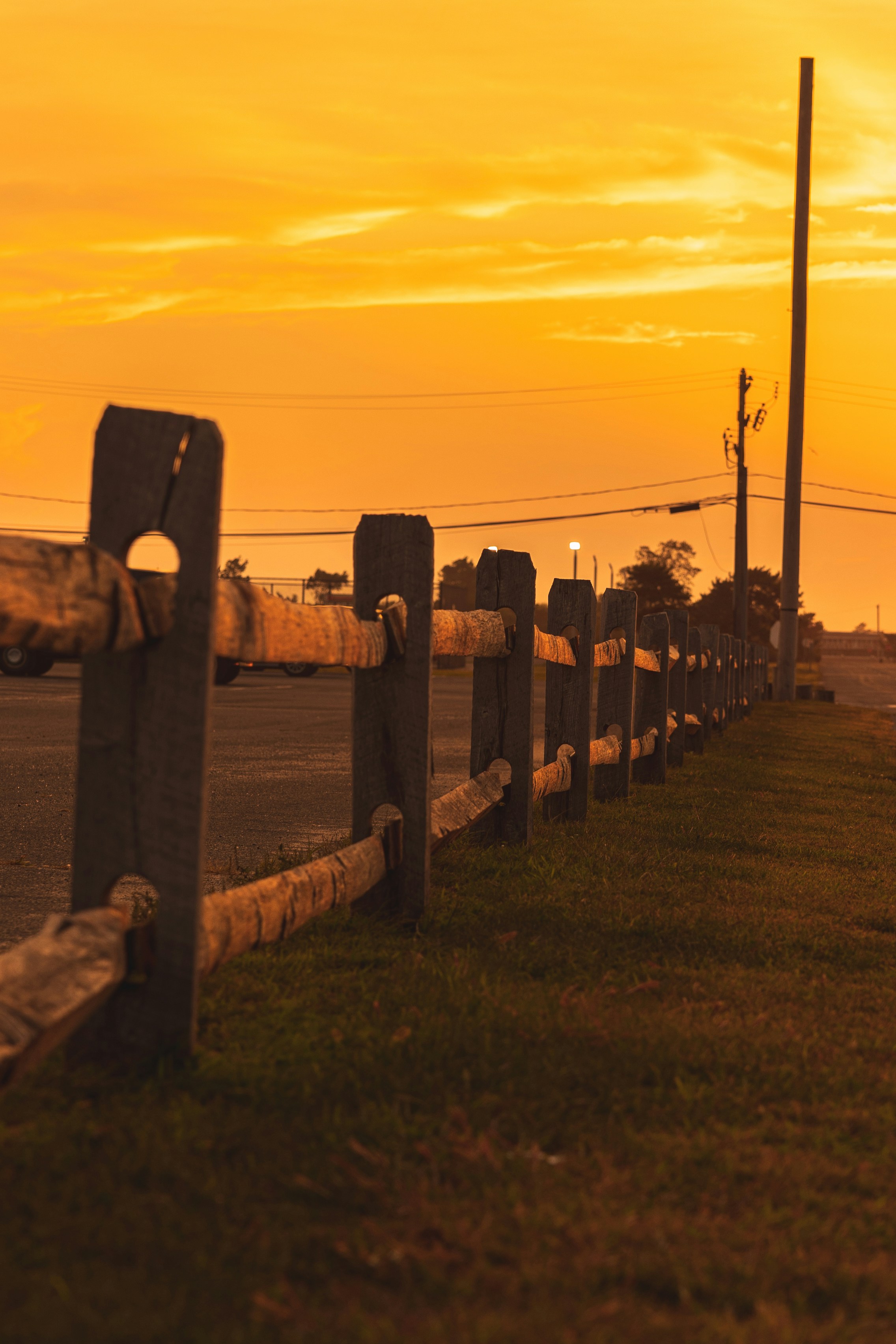 Horizon Rails: A Sunset Walk Along a Weathered Fence