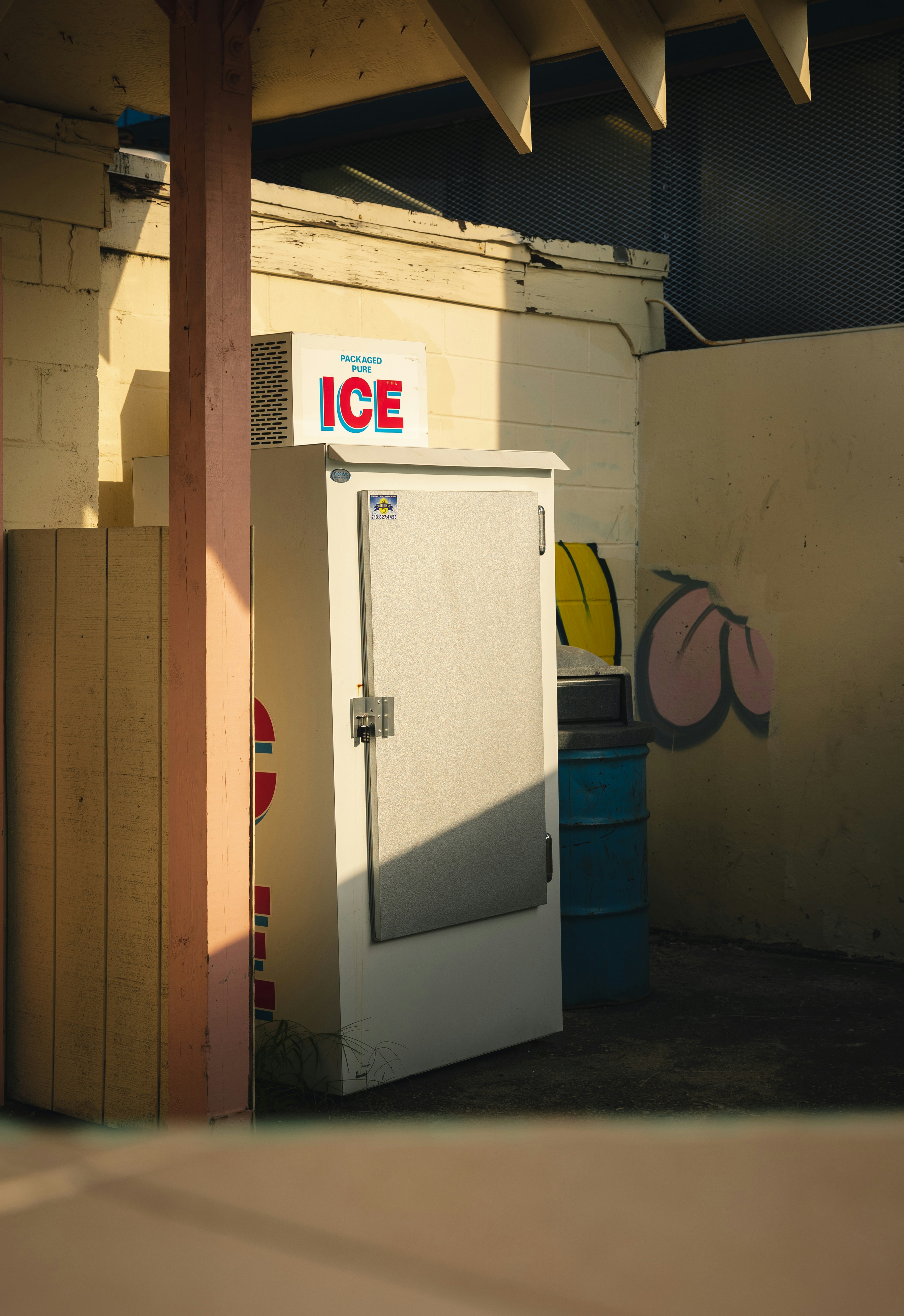 A white refrigerator freezer sitting next to a building photo – Free ...