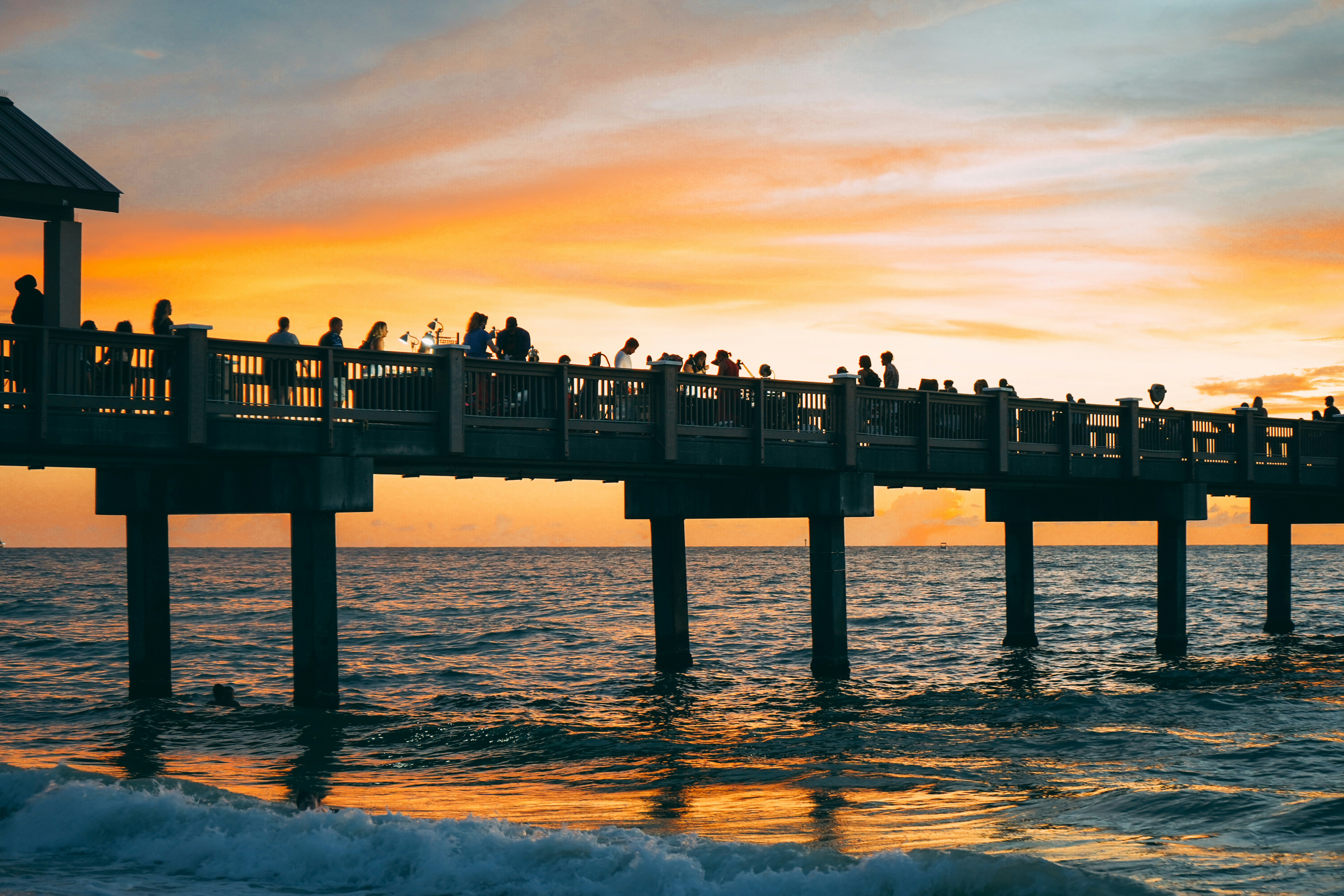 A group of people standing on top of a pier photo – Free Clearwater ...