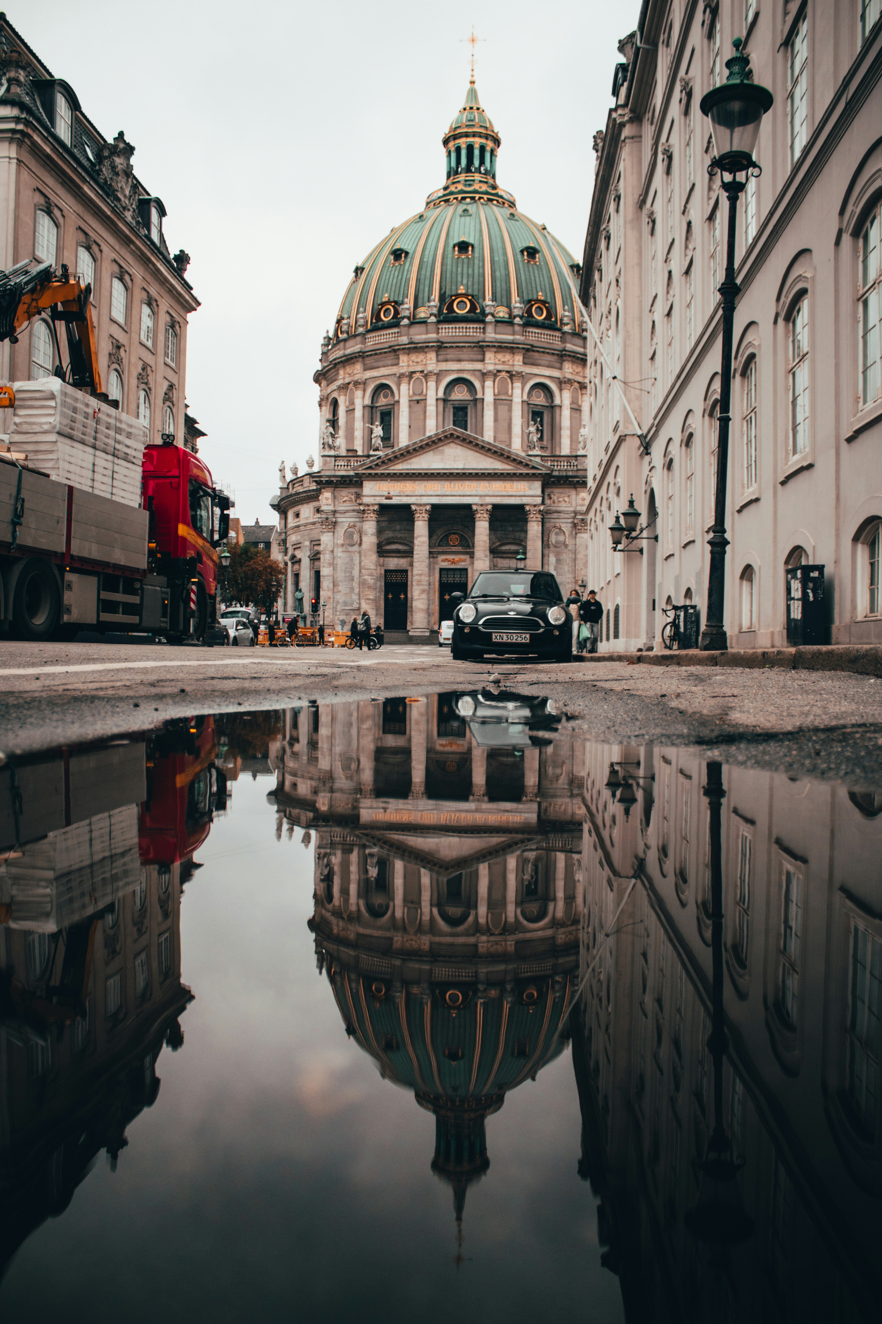 Dome Over a Rain-Washed Street: City Reflection in the Puddle