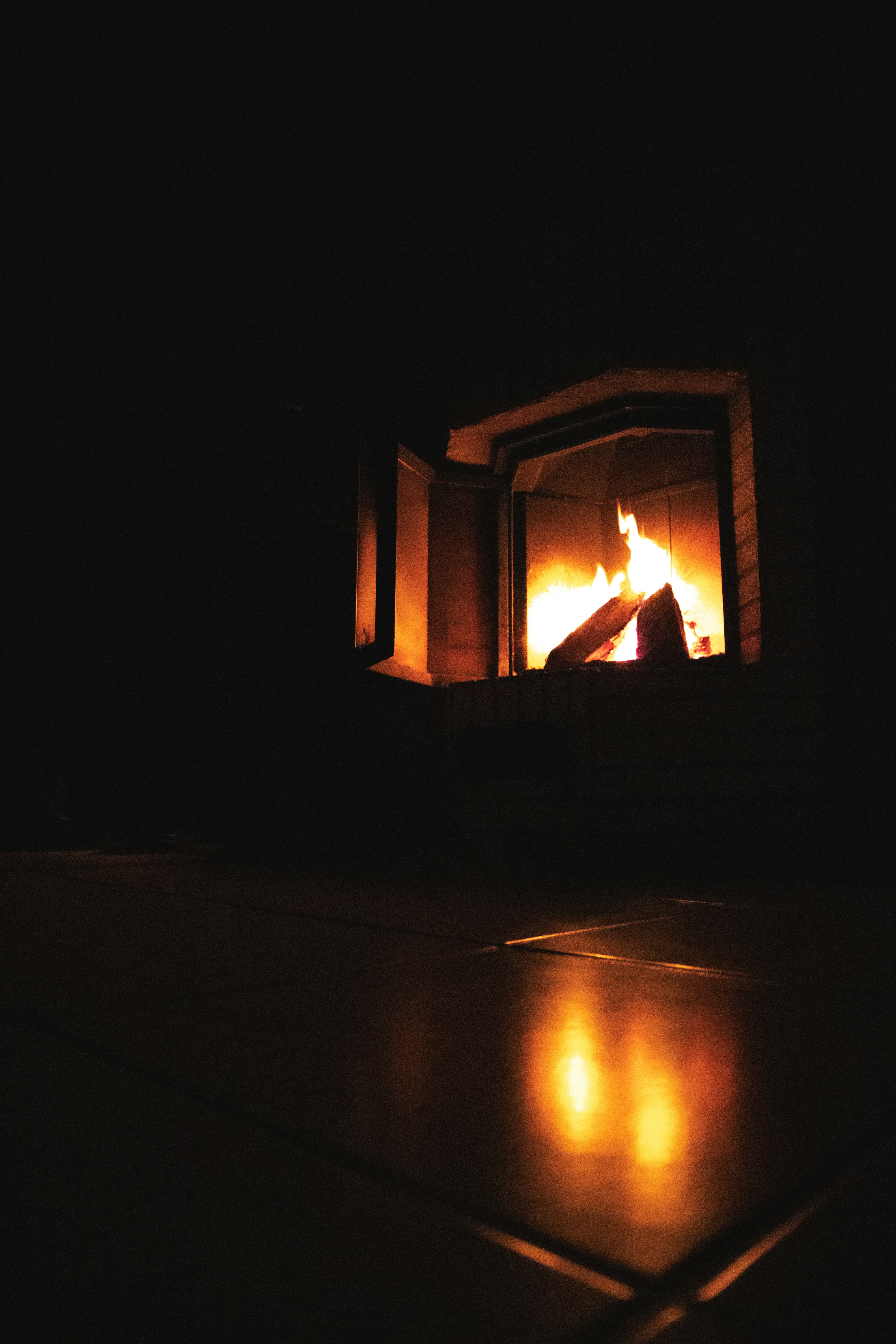 A fire burning in a fireplace in a dark room photo – Free Fire Image on ...