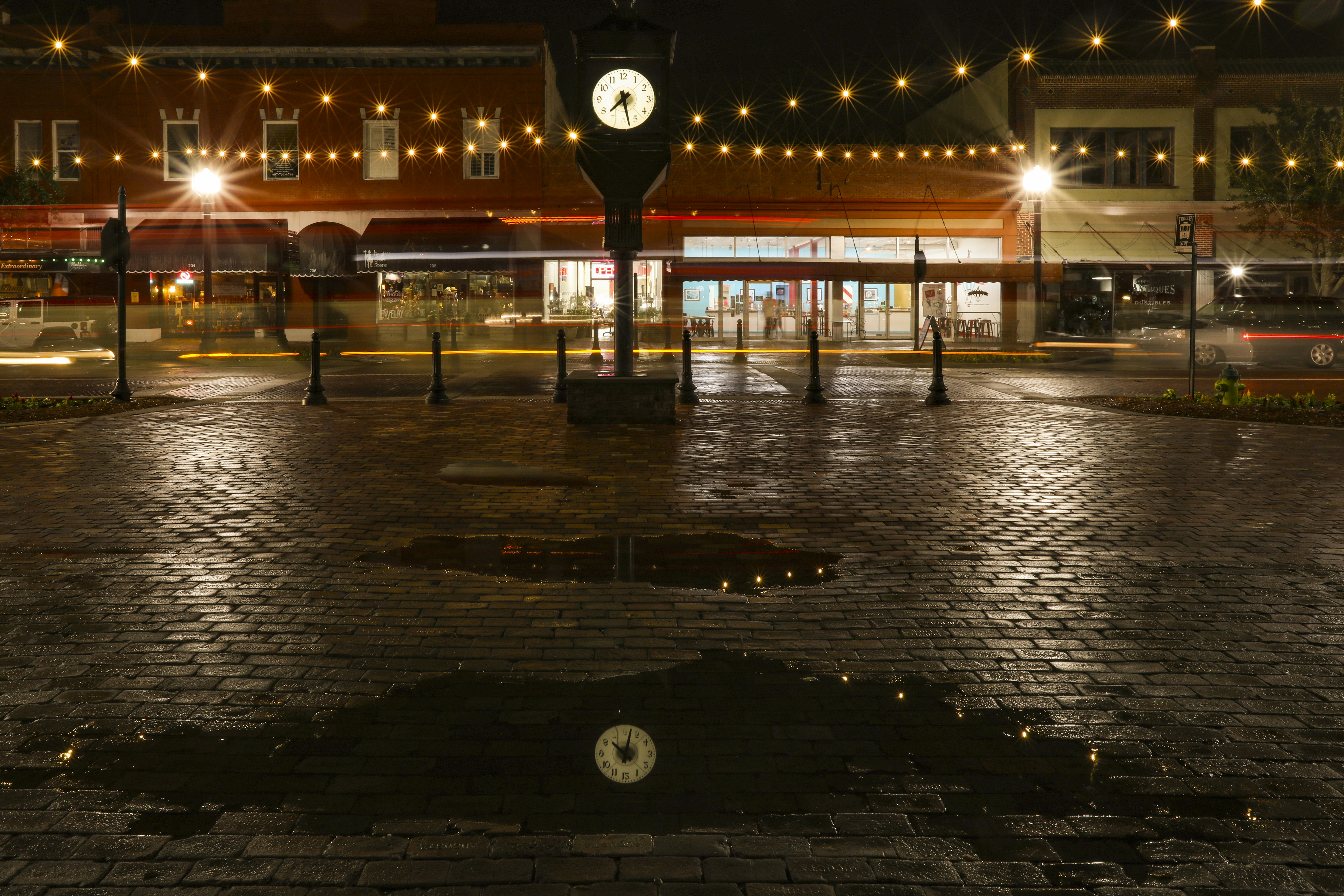 A clock on a pole in the middle of a street photo – Free Sanford Image ...