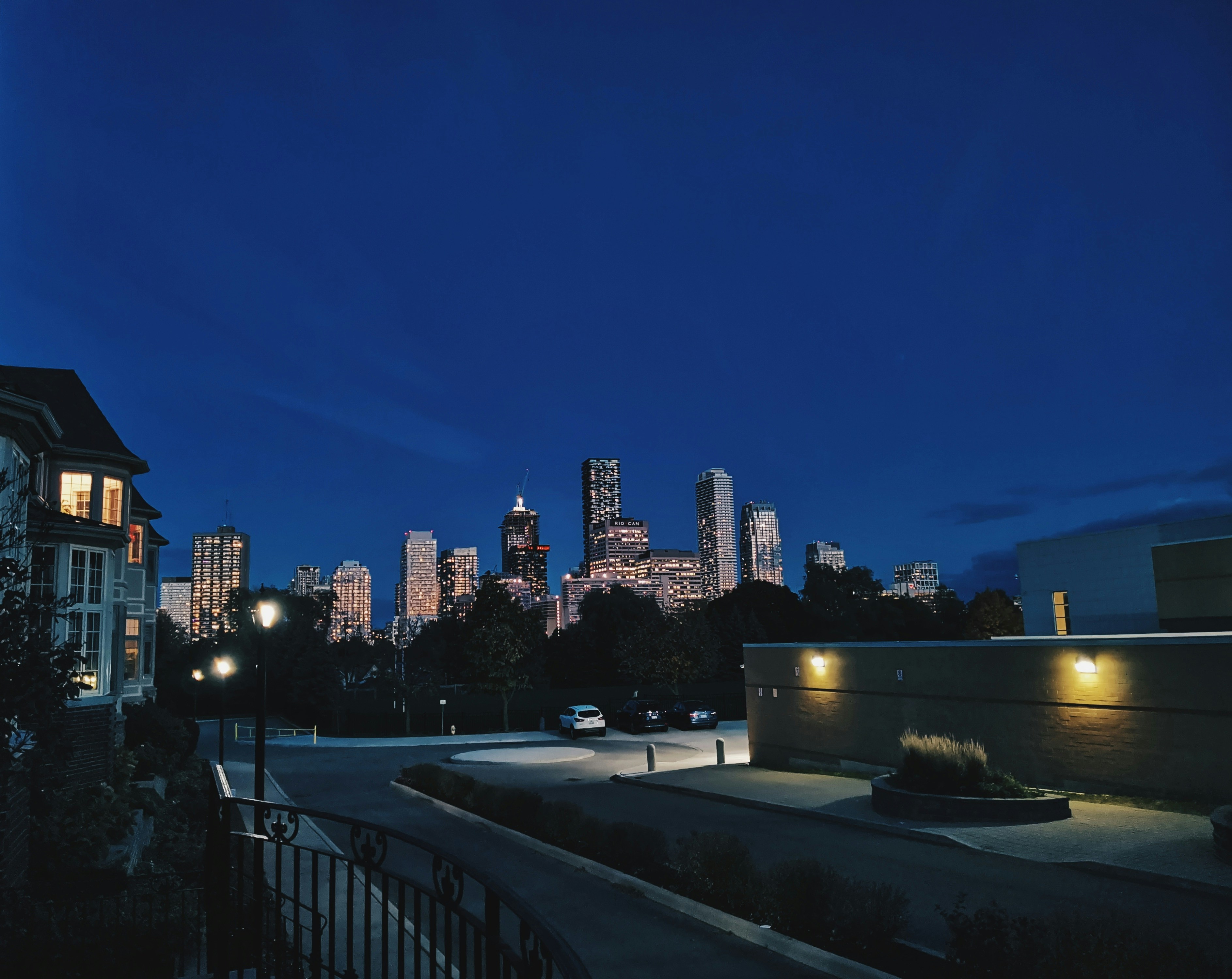Cityscape at Dusk: Neon Peaks Over Quiet Housing