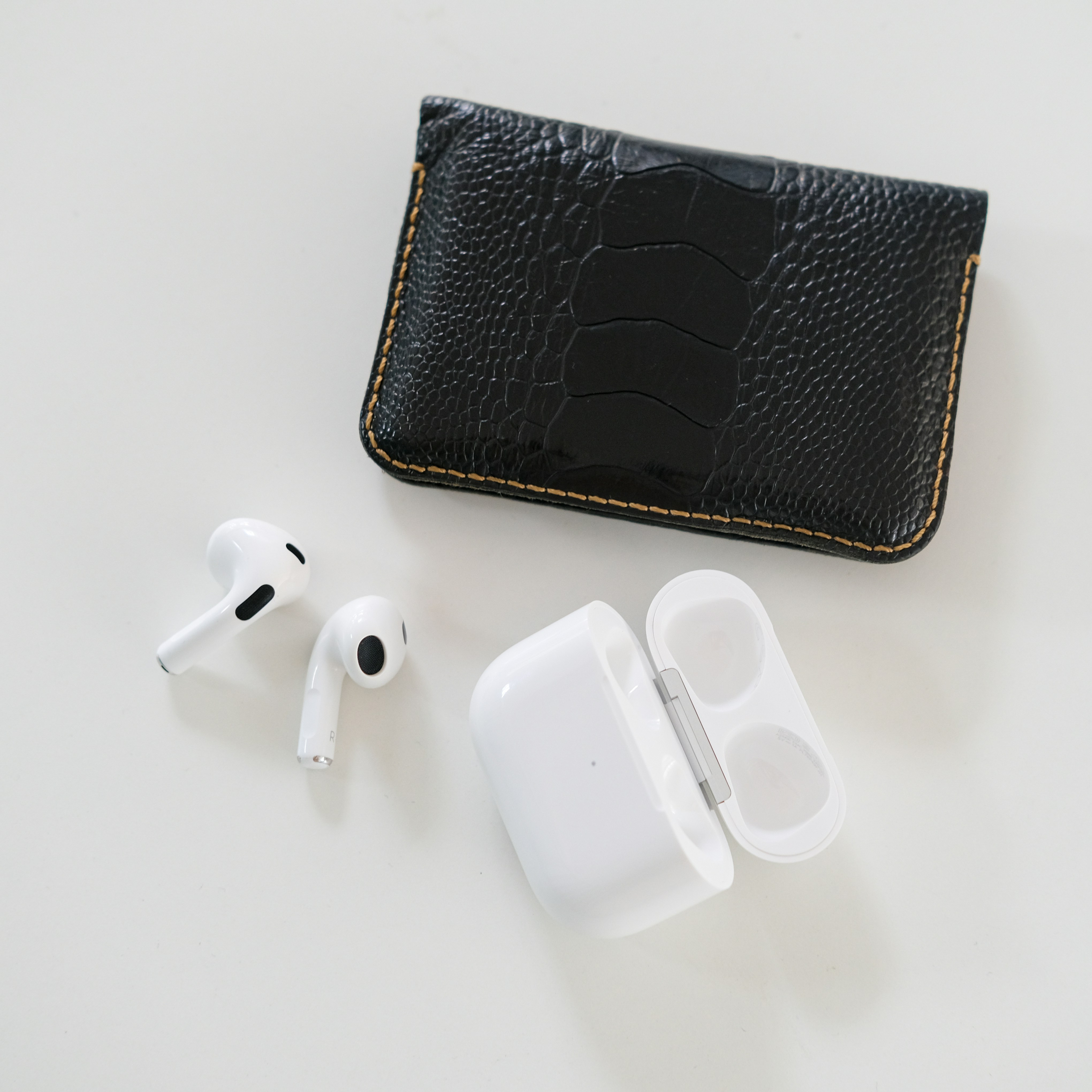 A pair of ear buds sitting next to a case photo – Free Apple Image on ...