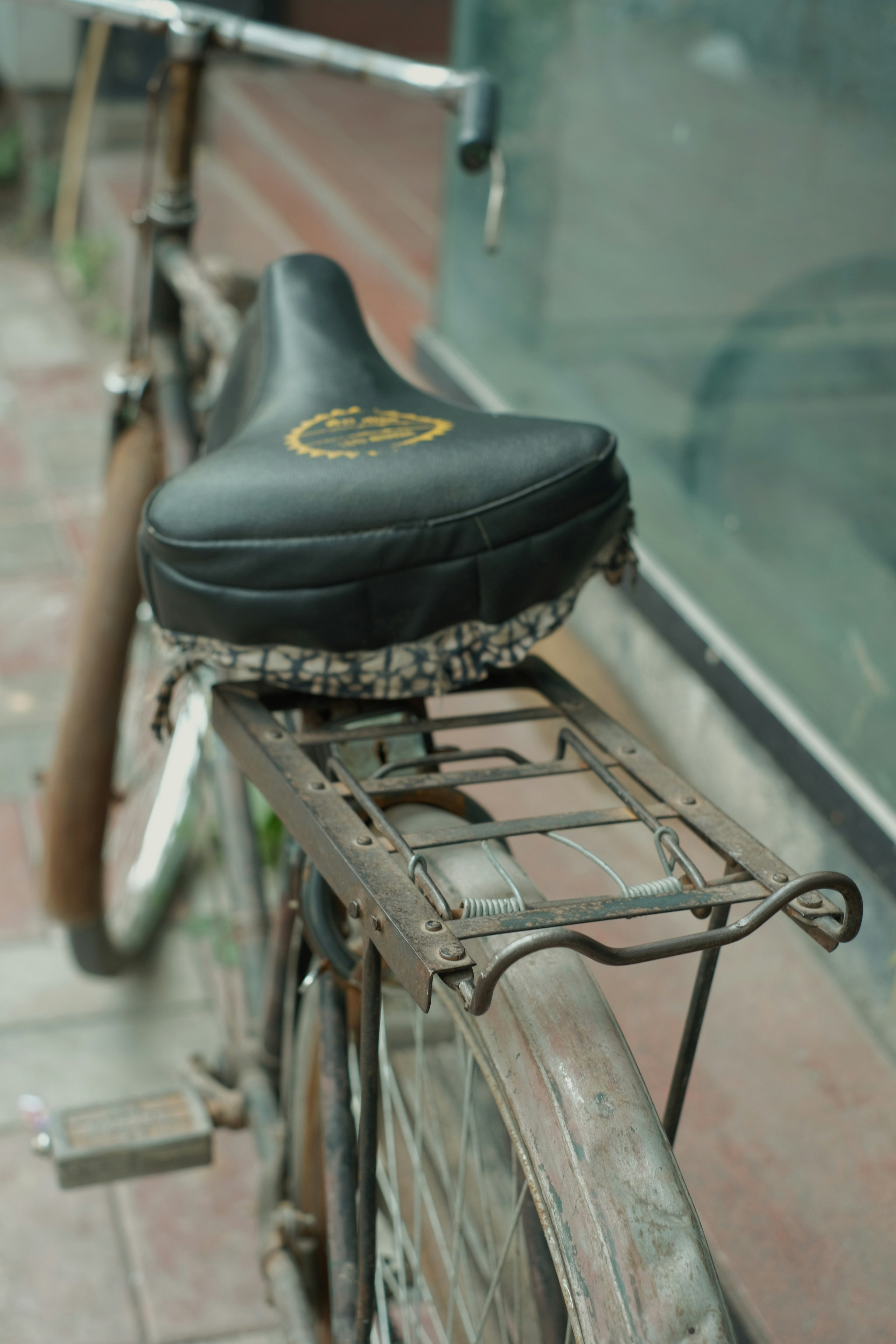 a close up of a bicycle parked on a sidewalk