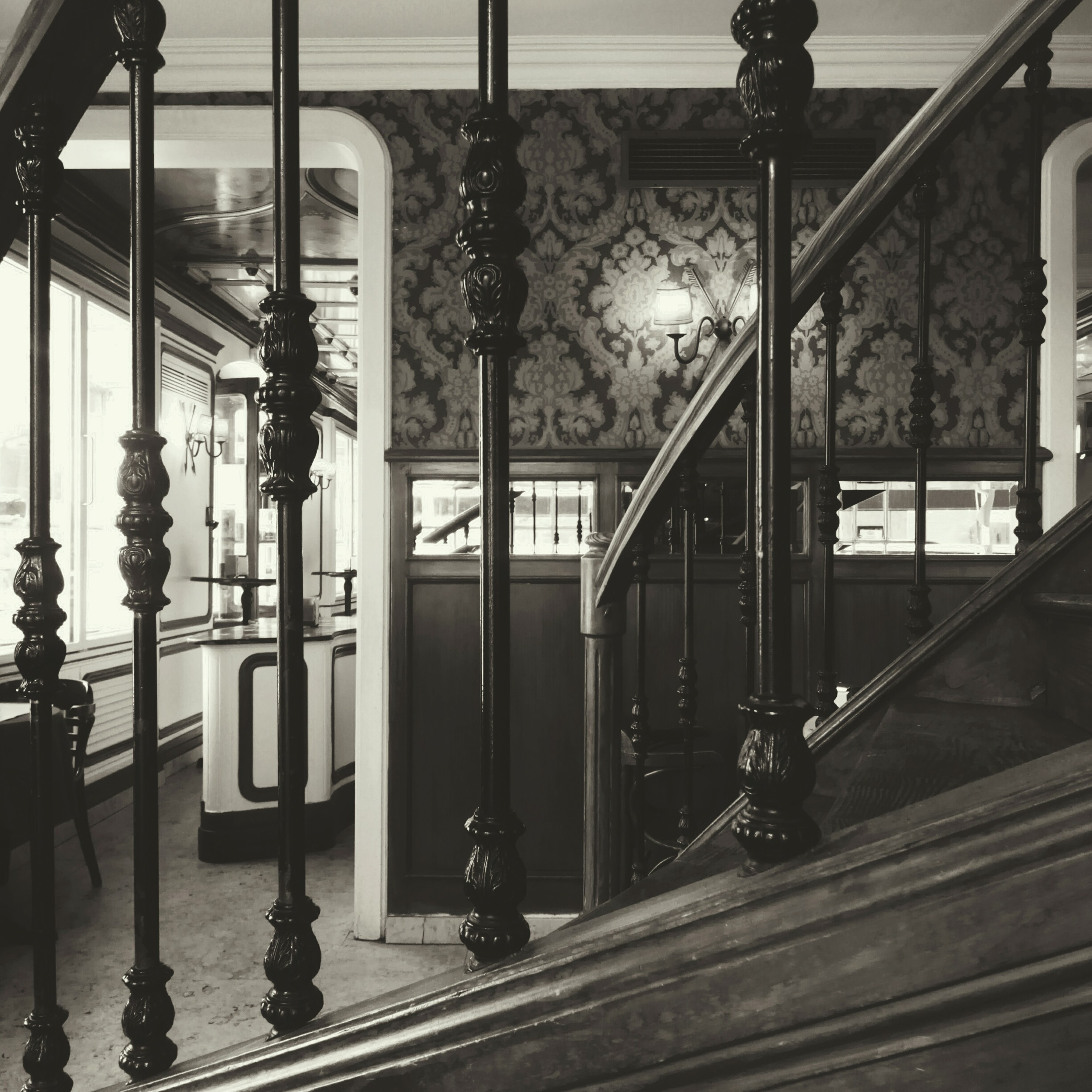 Intricate stairway leading to an inviting space adorned with vintage decor and warm lighting.
