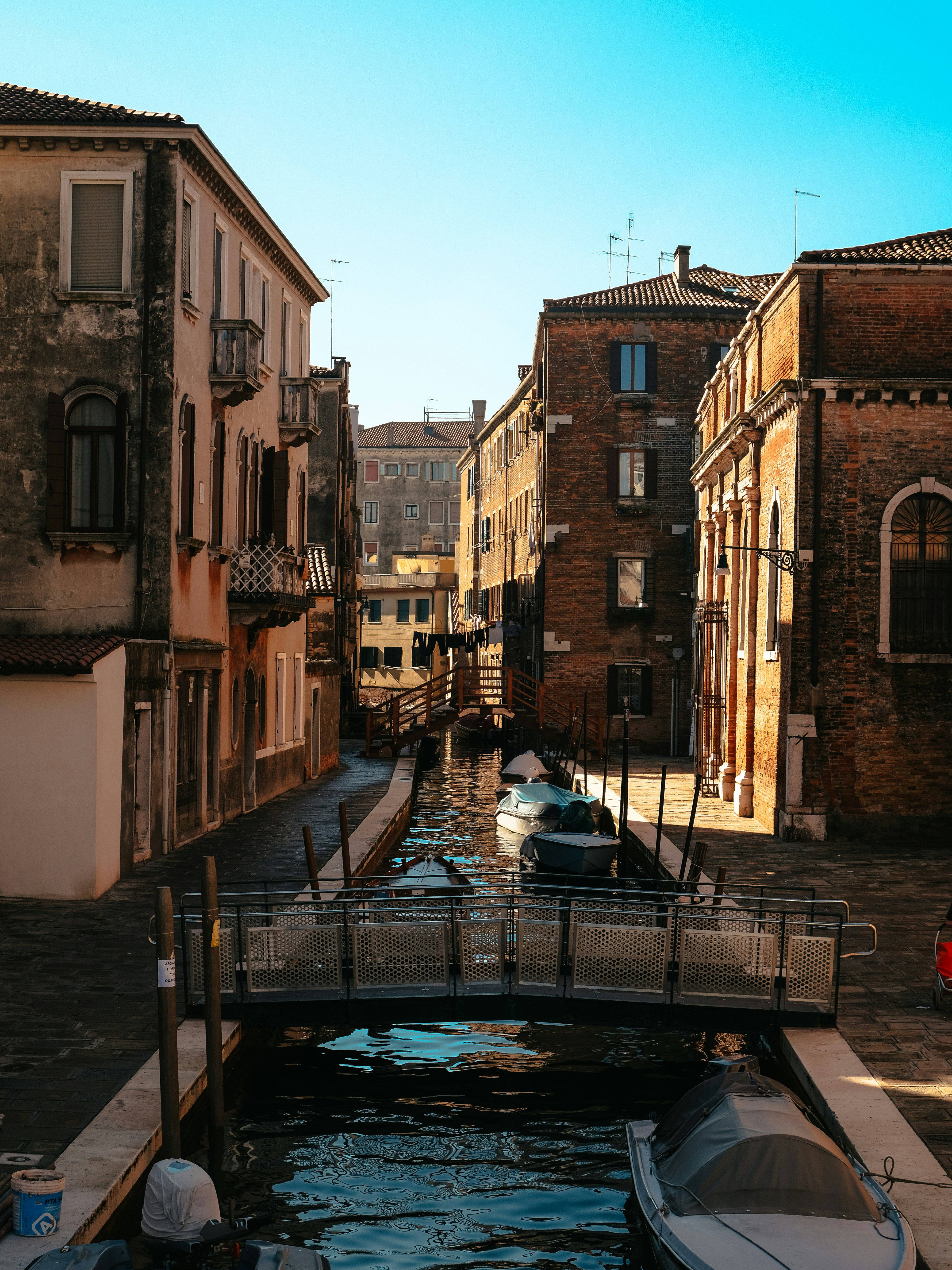 Sunlit Brick and Water: A Quiet Canal in Venetian Light