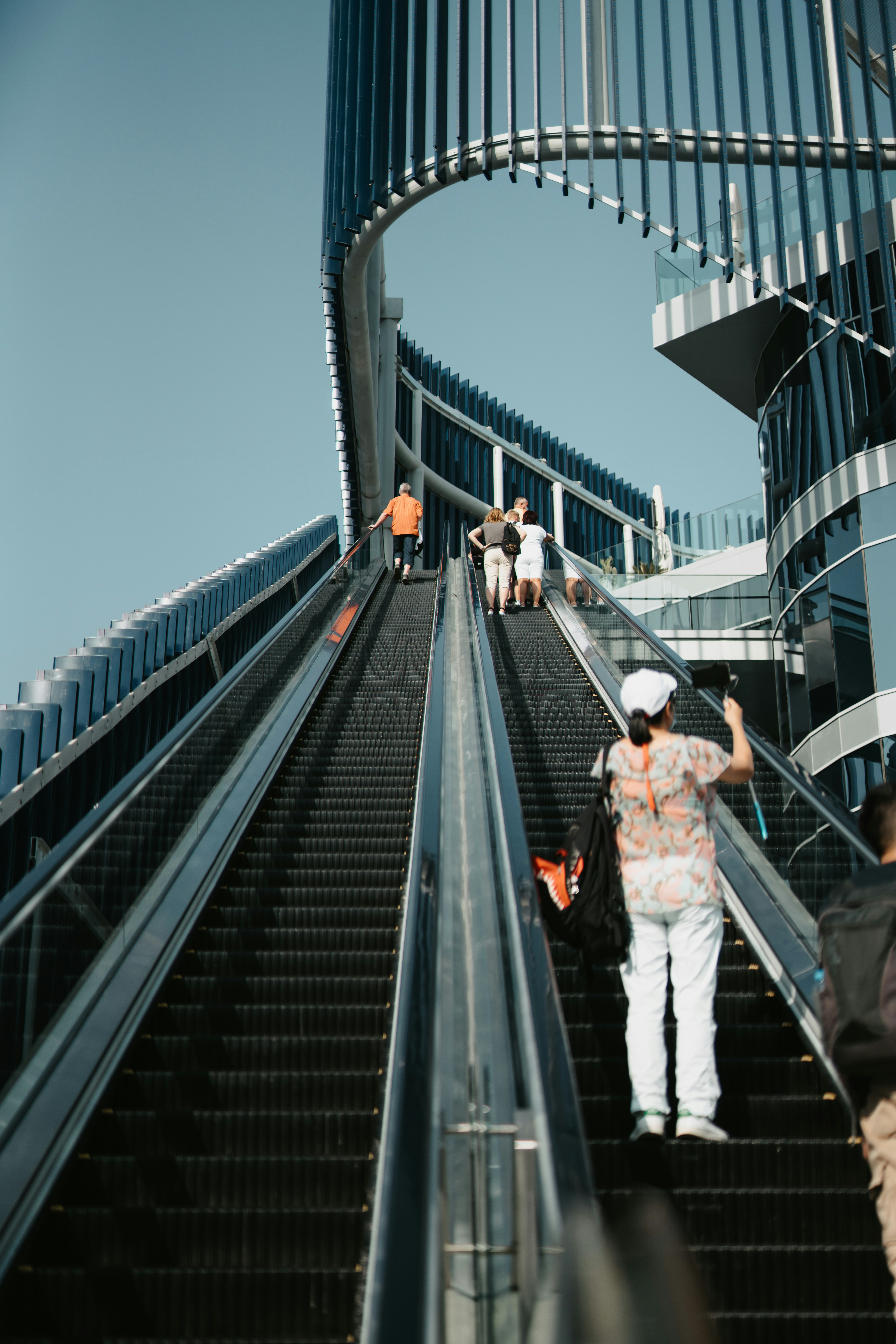 A group of people walking up a set of stairs photo – Free Dubai ...