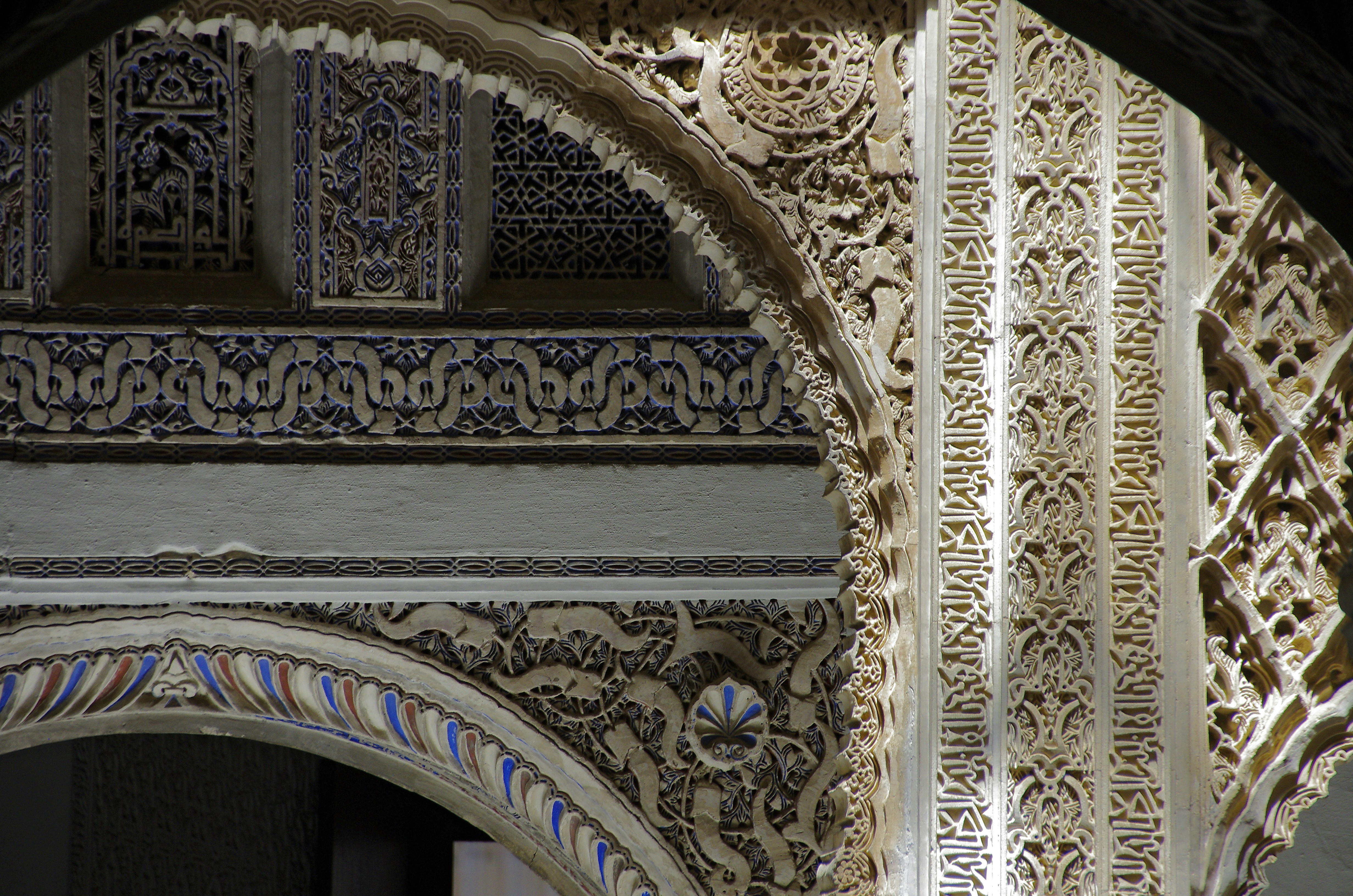 Detailed stone arch showcasing Moorish architectural patterns with ornate carvings and geometric designs.