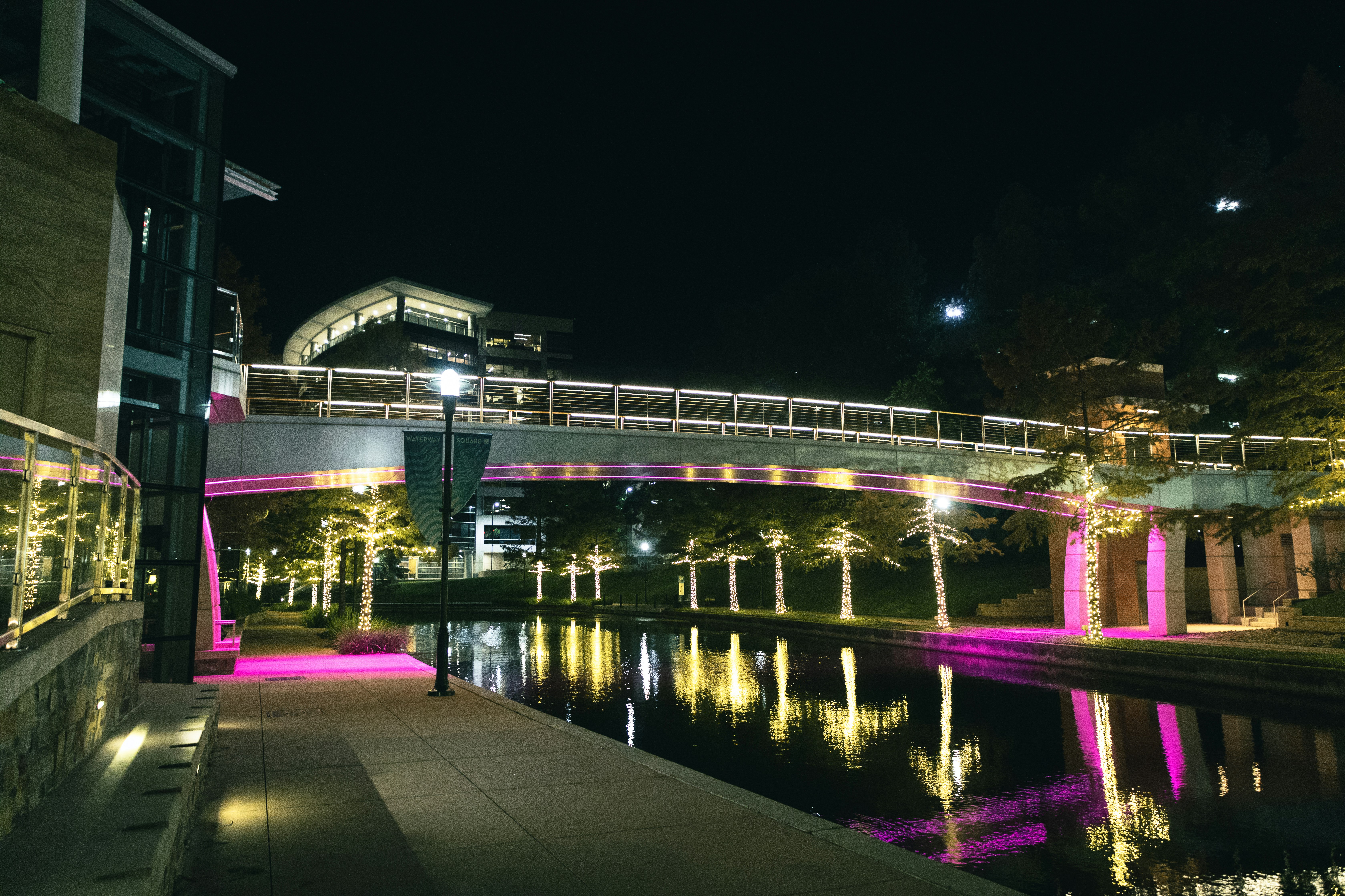 A bridge that has lights on it over a body of water photo – Free ...