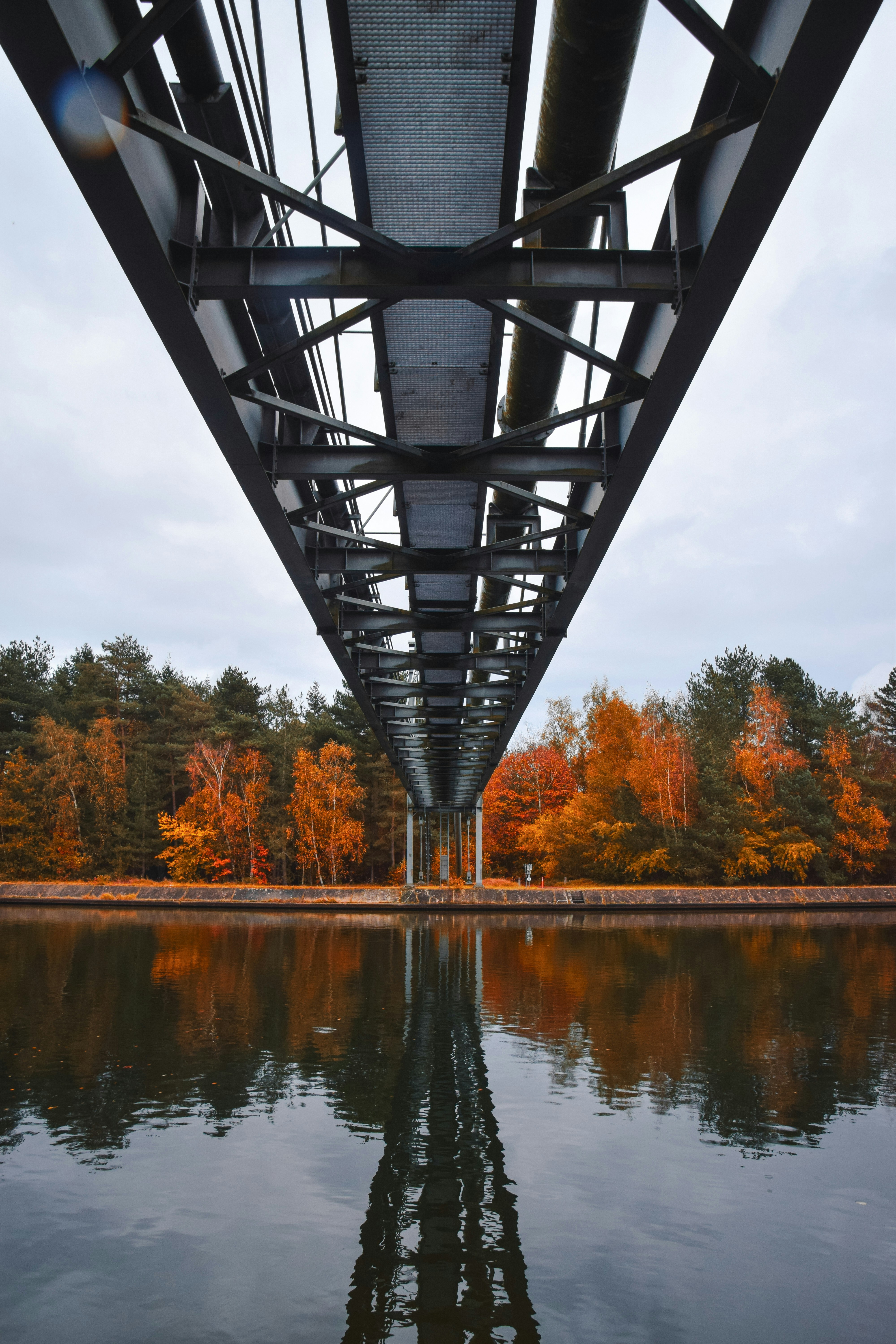 The underside of a bridge over a body of water photo – Free Fall Image ...