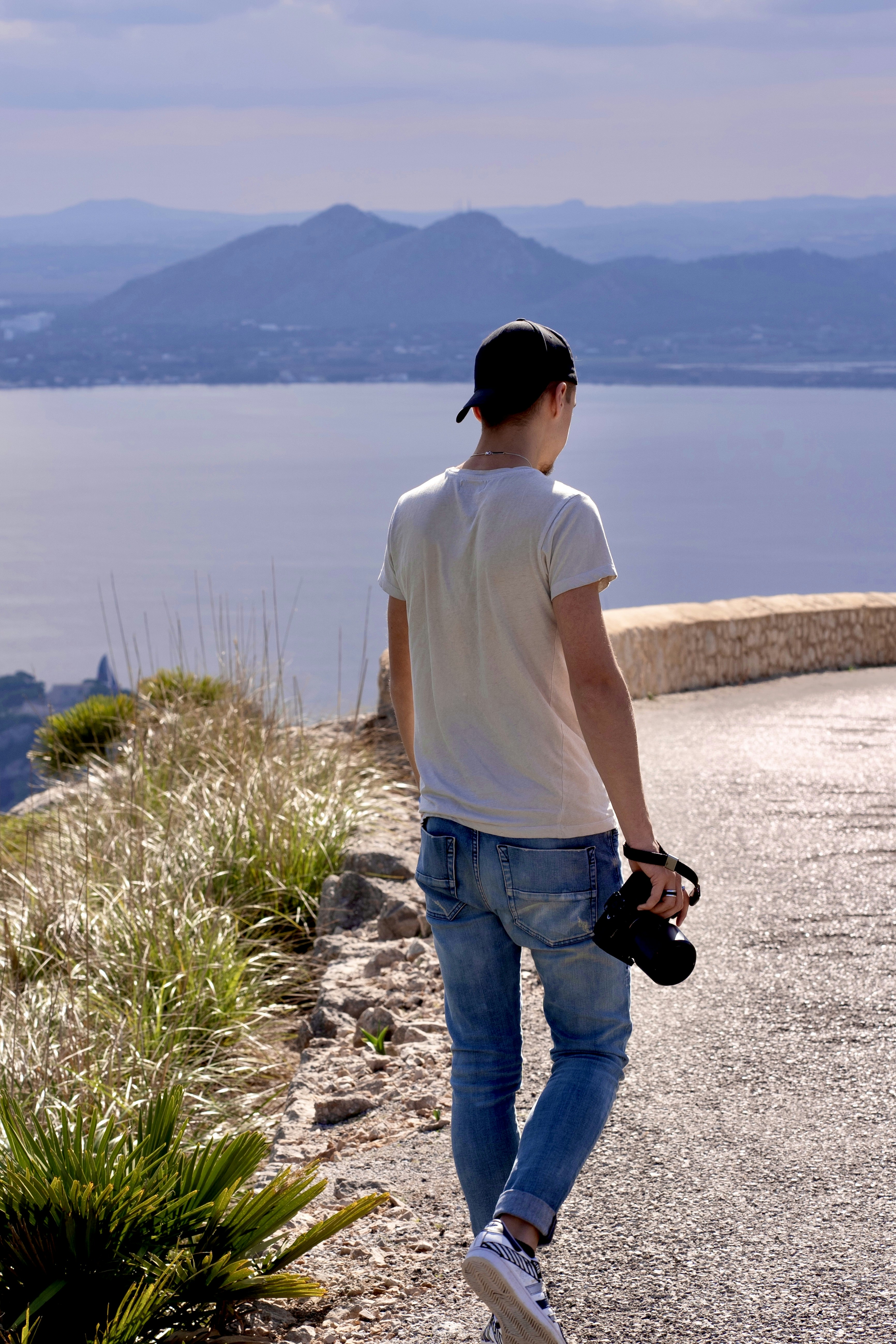 Traveler with a Lens Overlooking the Sea Cliffs