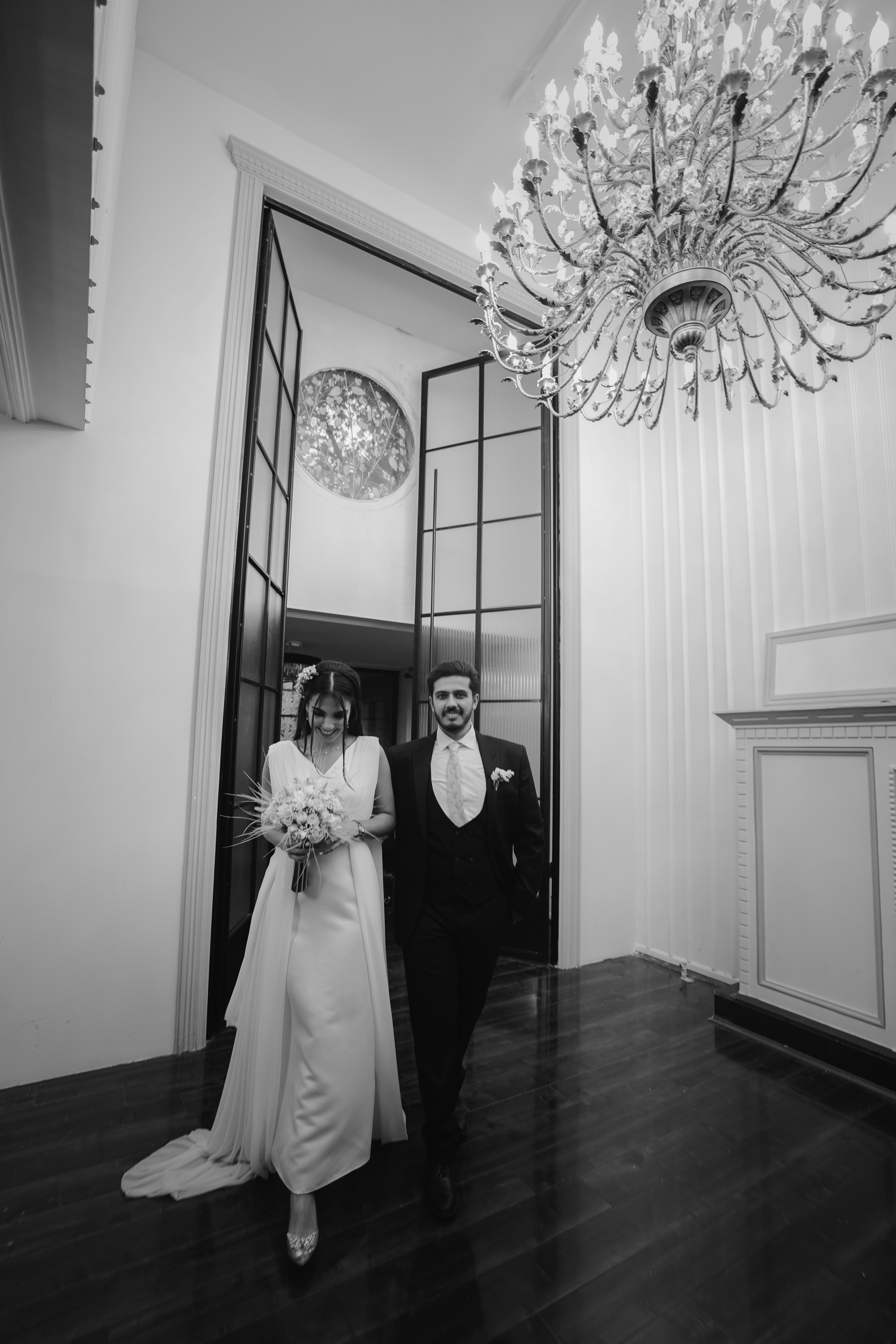 A man and a woman walking down a hall together photo – Free Grey Image ...