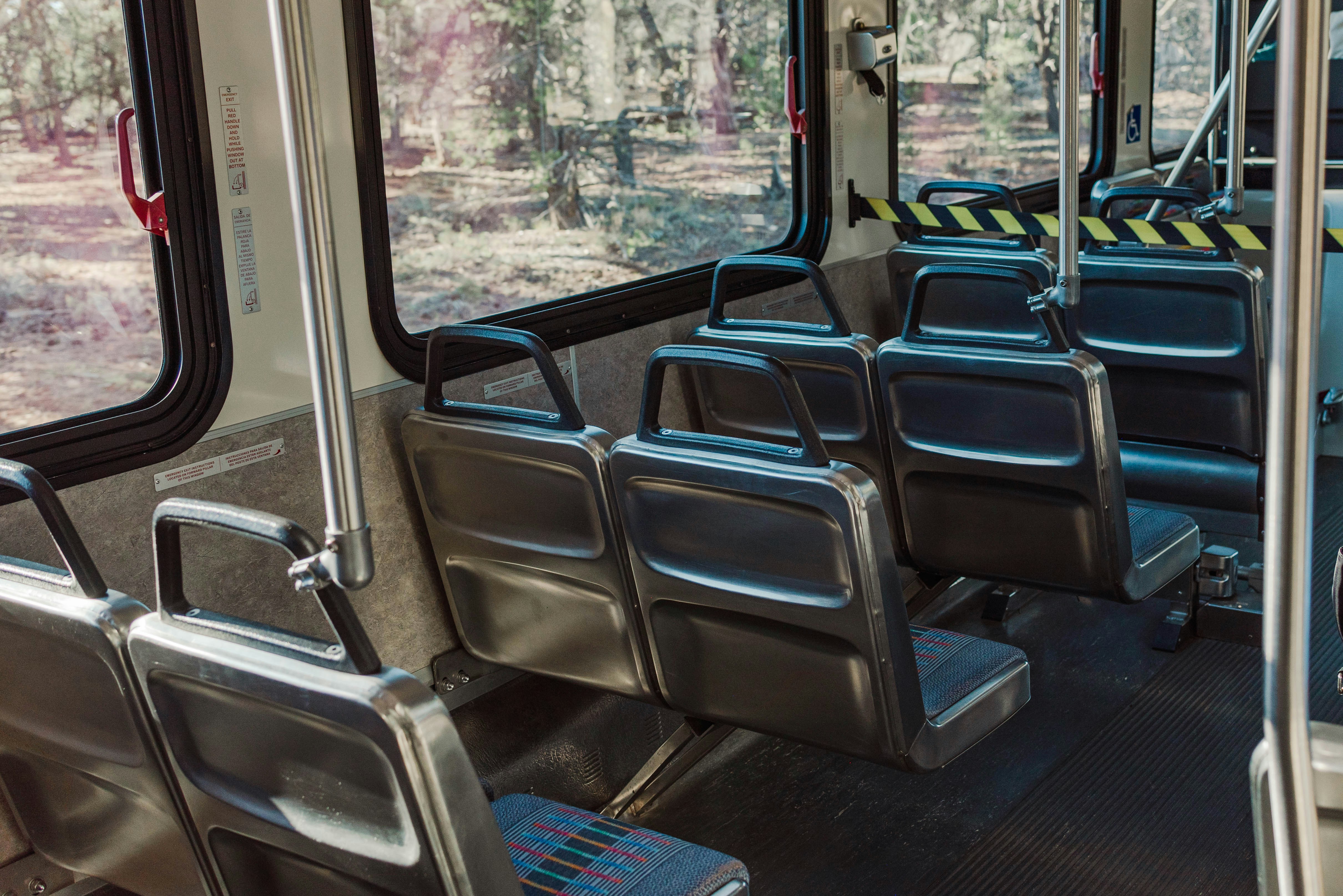 A row of empty seats on a public transit bus photo – Free Bus Image on ...