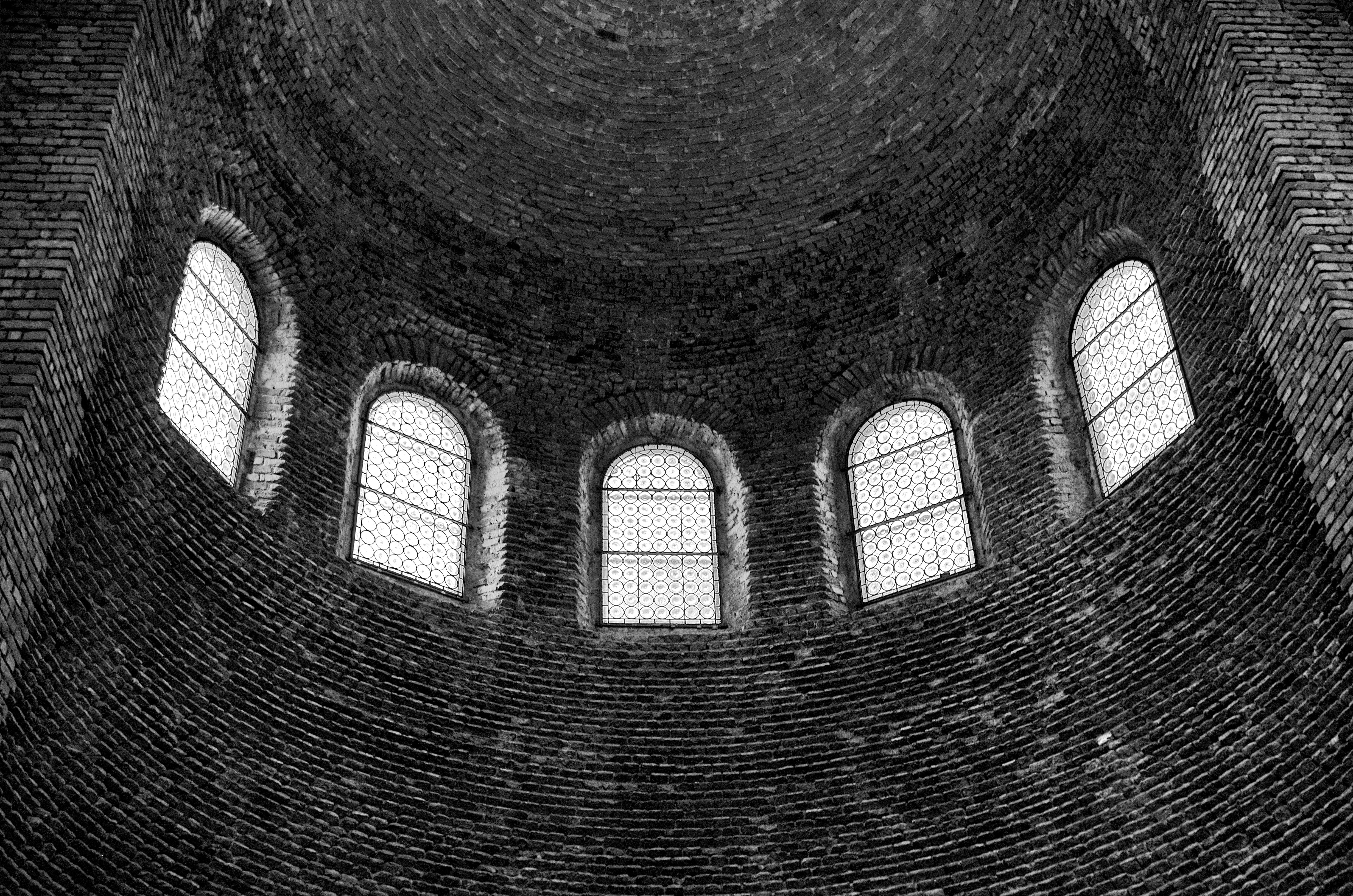 Arts & Culture
 | a black and white photo of three windows in a brick building