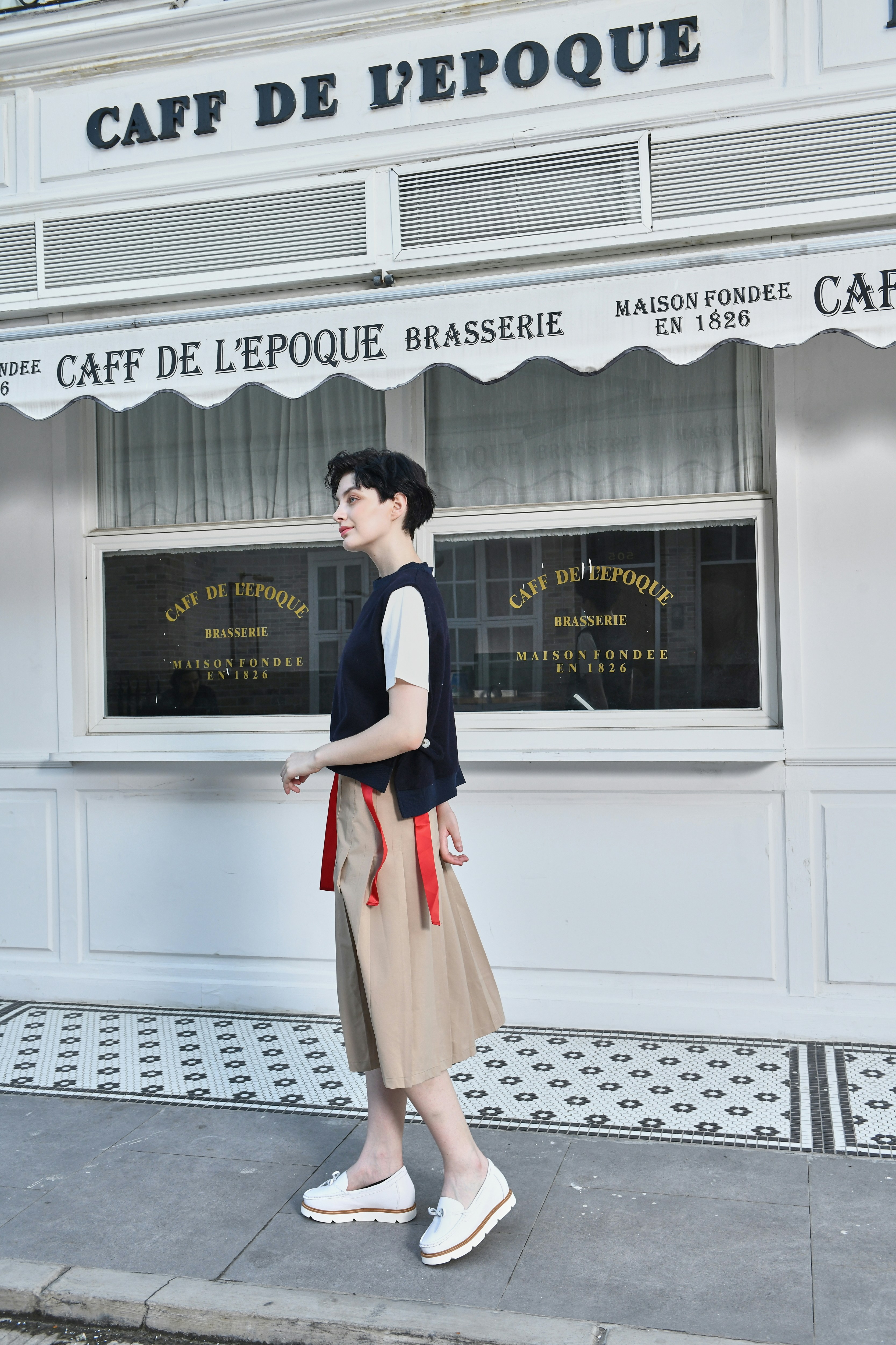 Midday Walk: A Contemporary Silhouette at a Parisian Cafe Facade