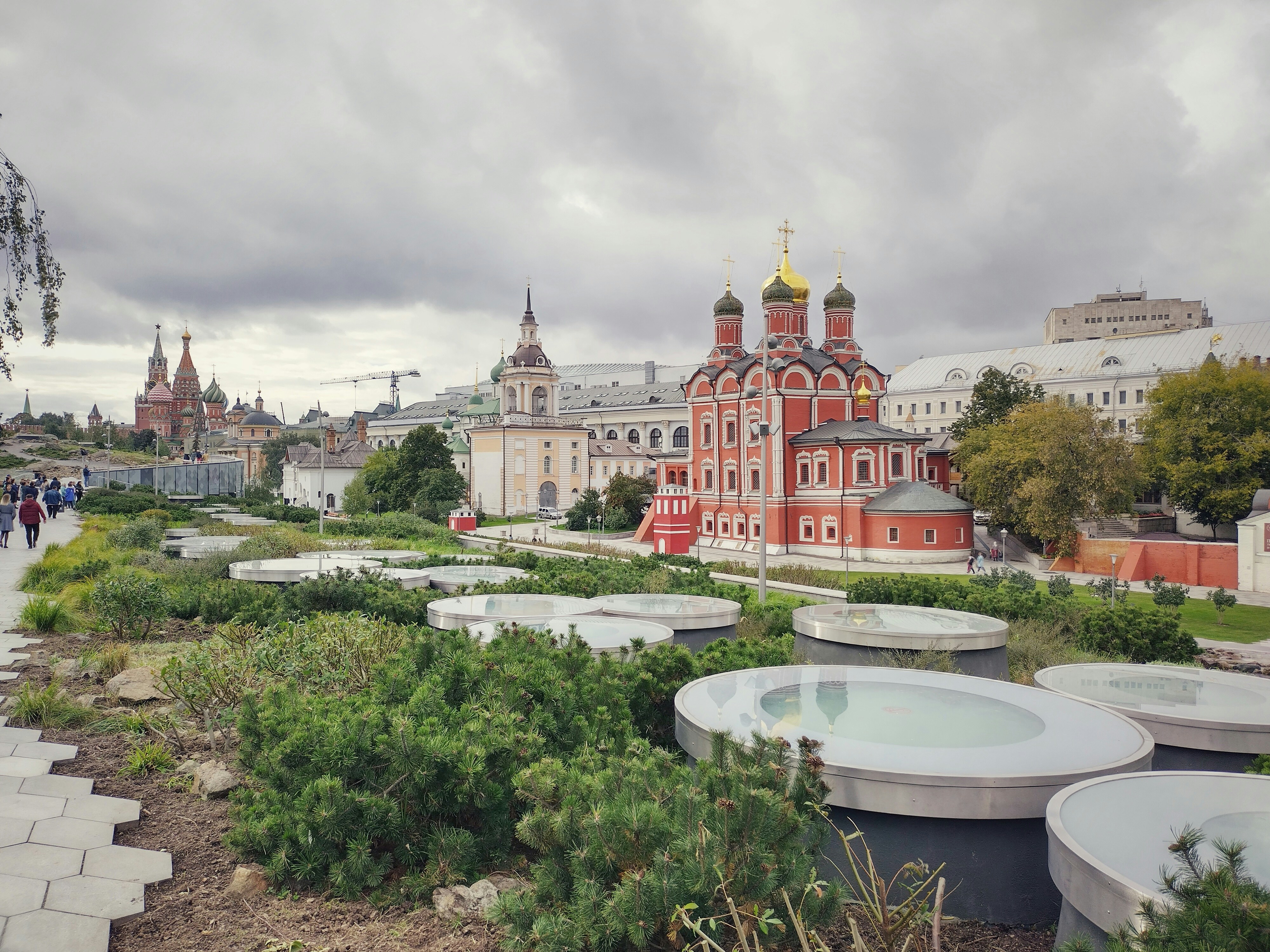 a large building with a lot of plants in front of it