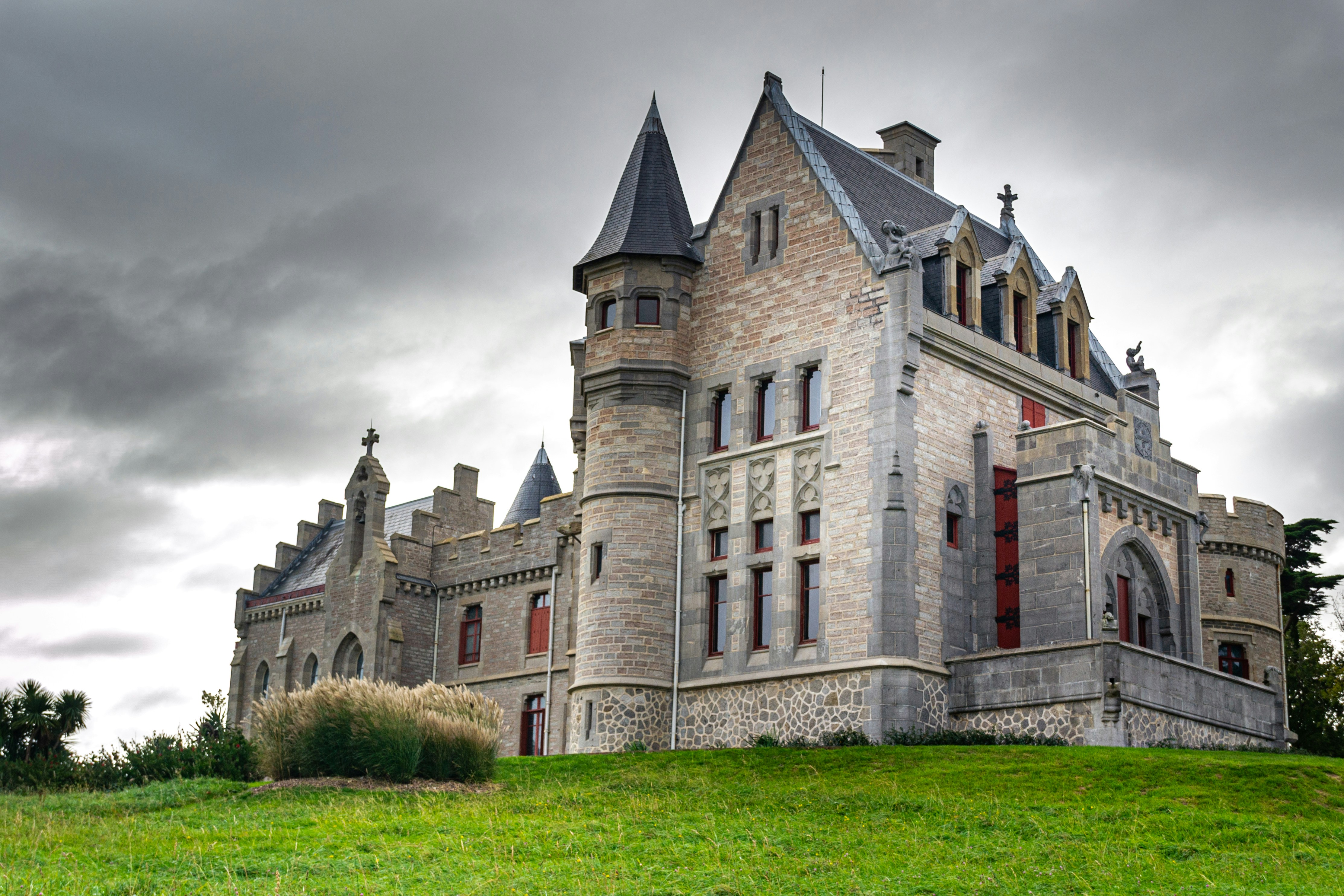 A castle like building on a grassy hill photo – Free Francia Image on ...