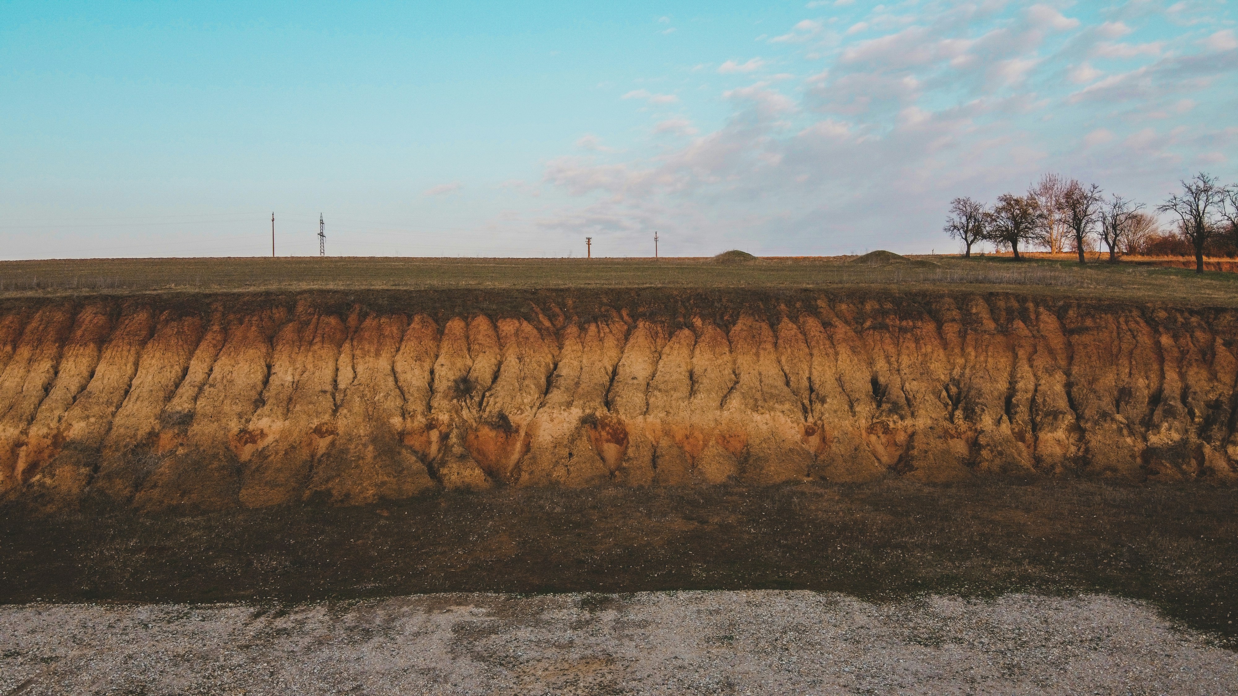 Horizon Ridges: Earth Toned Field Under a Clear Sky