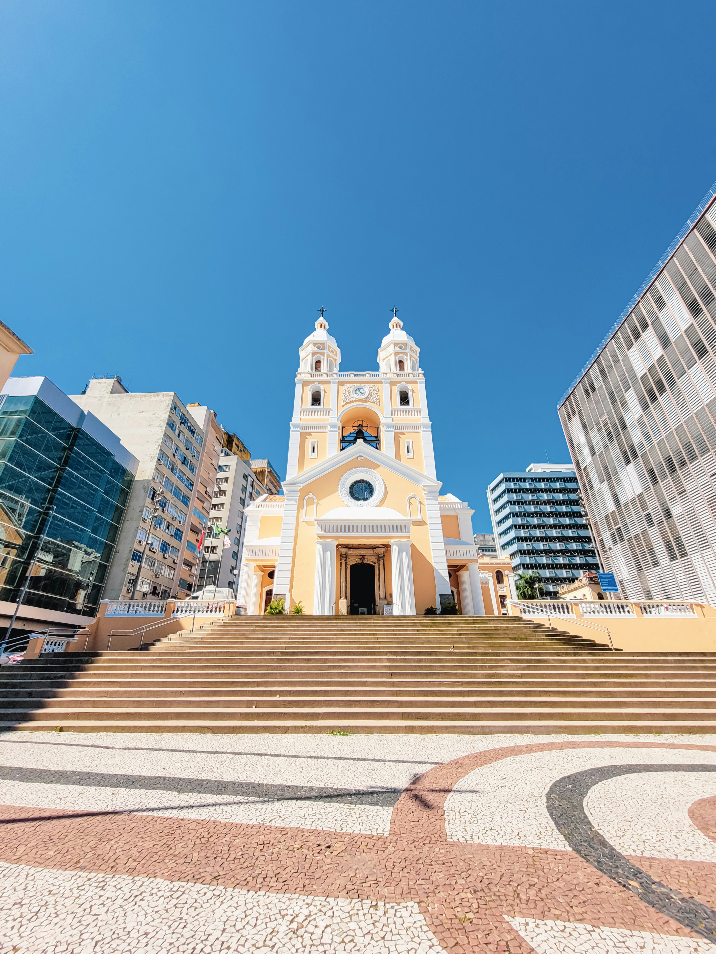 Staircase to a Sunlit Cathedral Amid Modern Facades