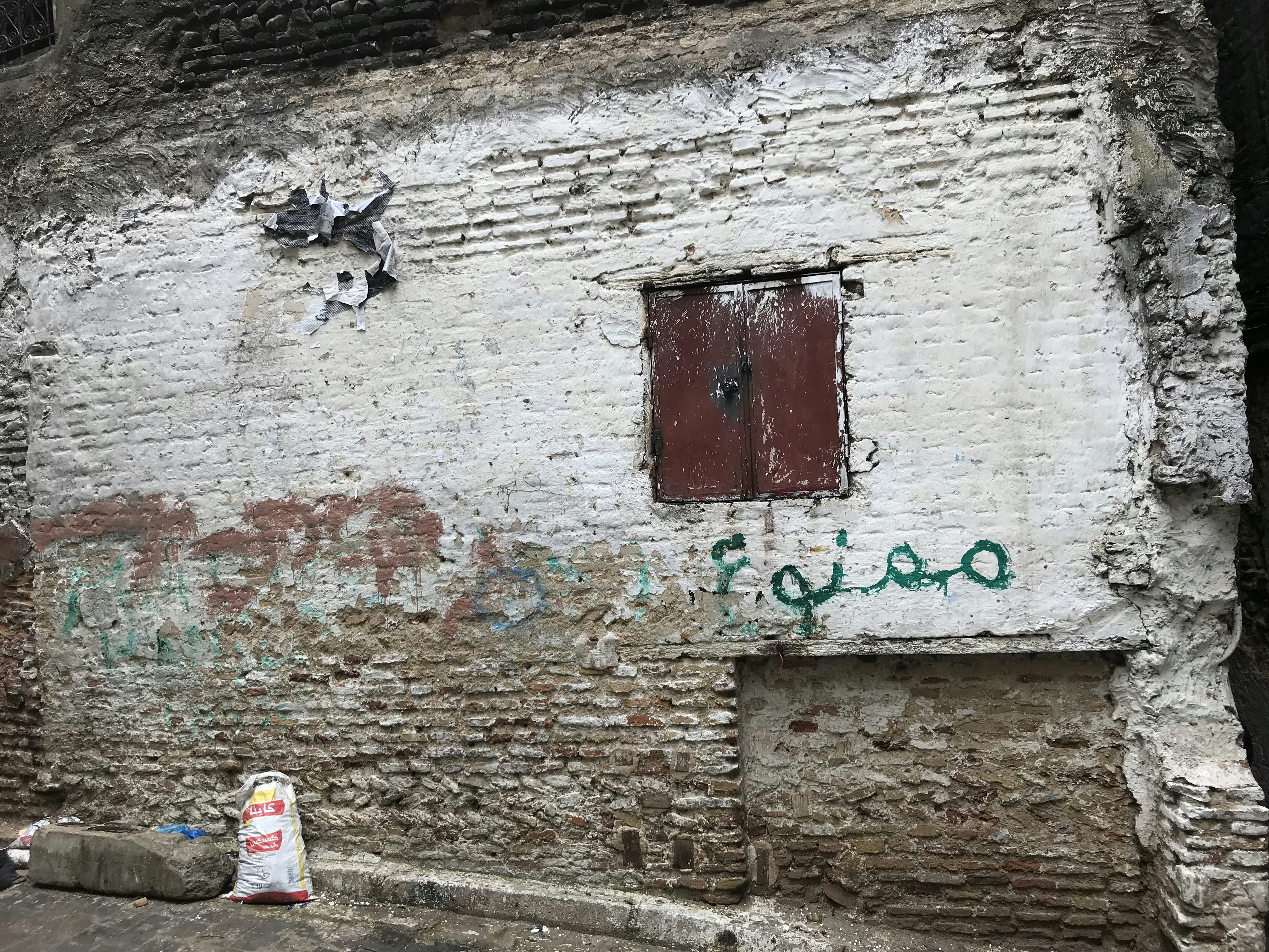 an old building with graffiti on the side of it