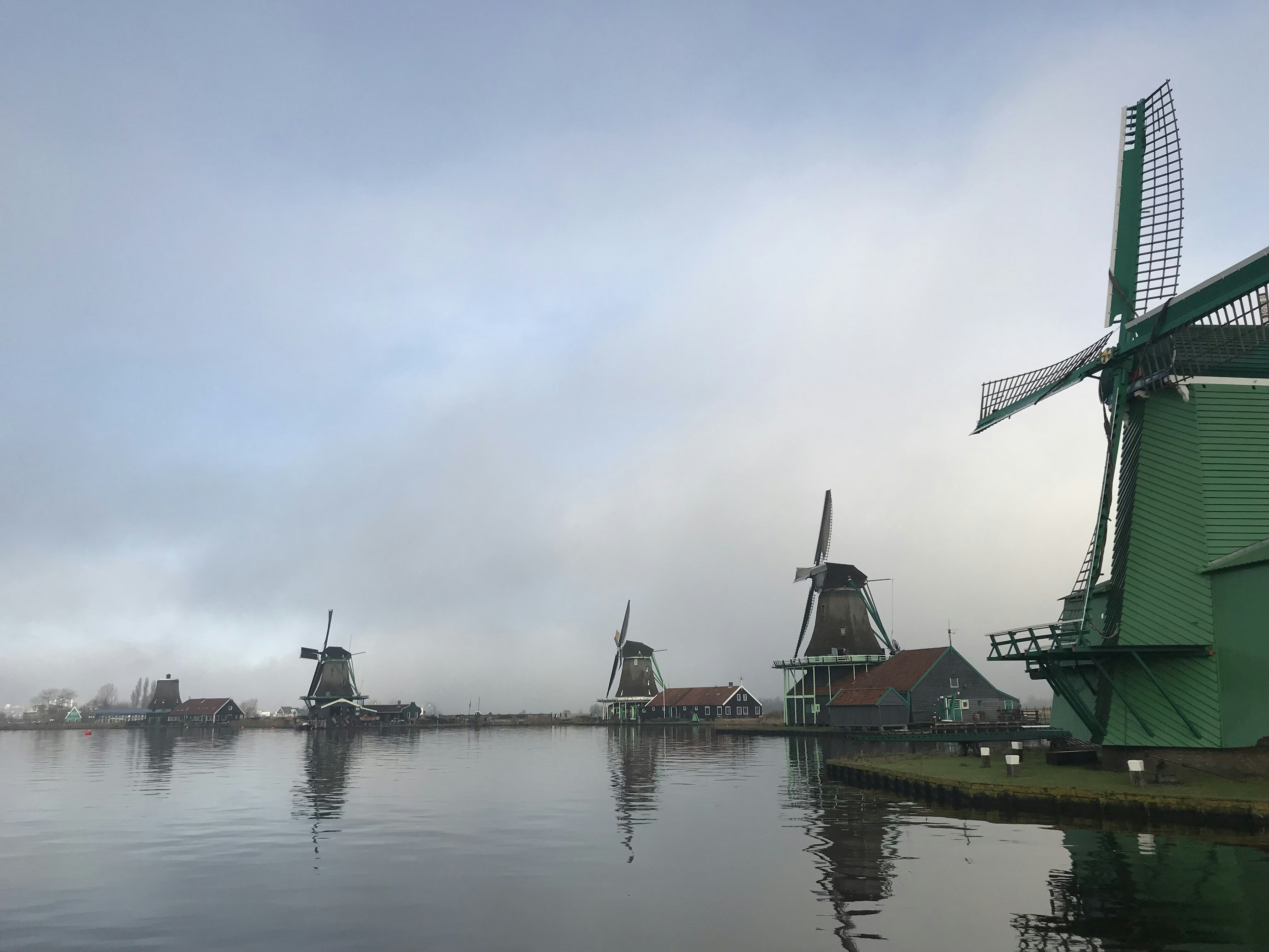 a group of windmills sitting on top of a lake