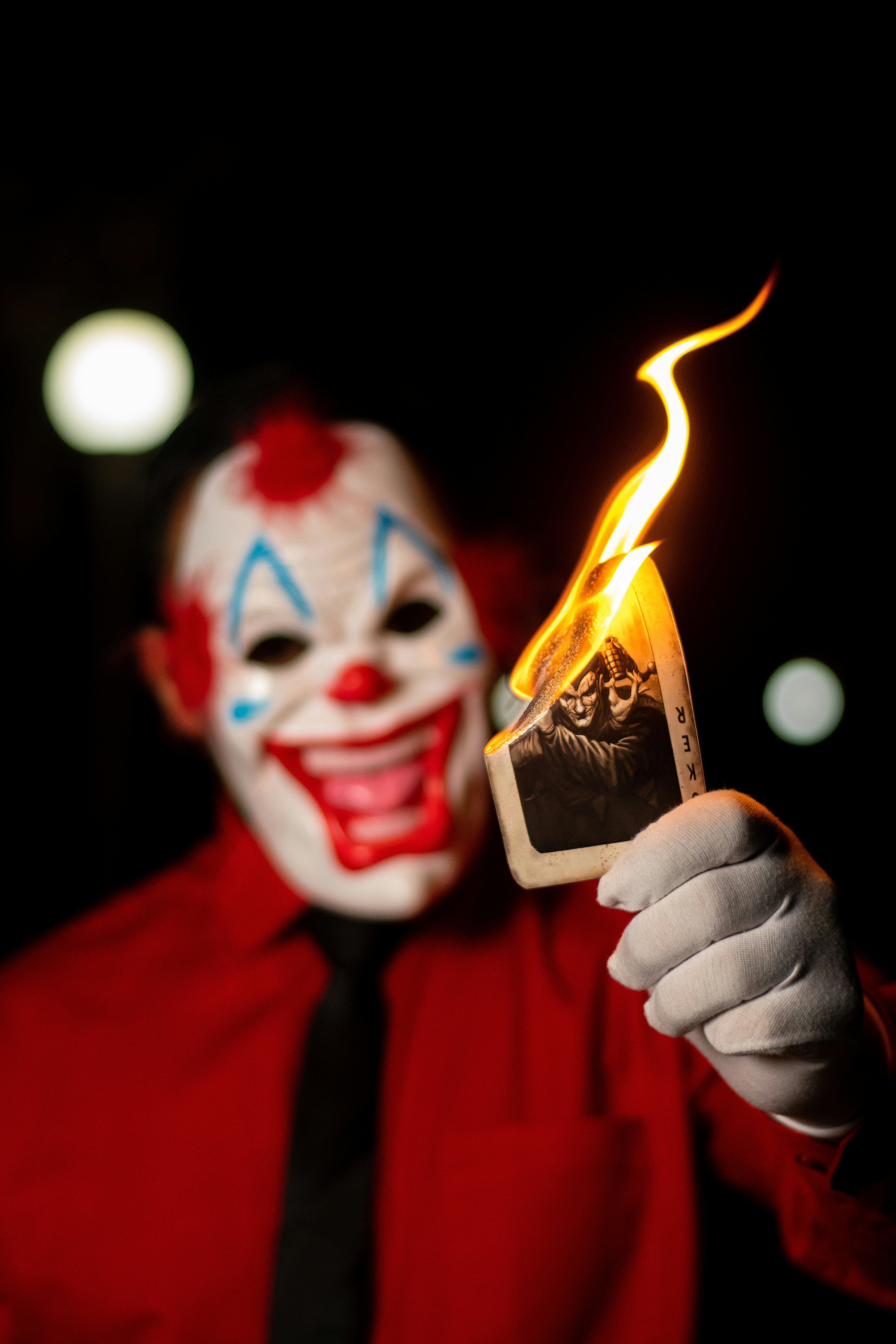 A man in a clown mask holding a cell phone photo – Free Human Image on ...