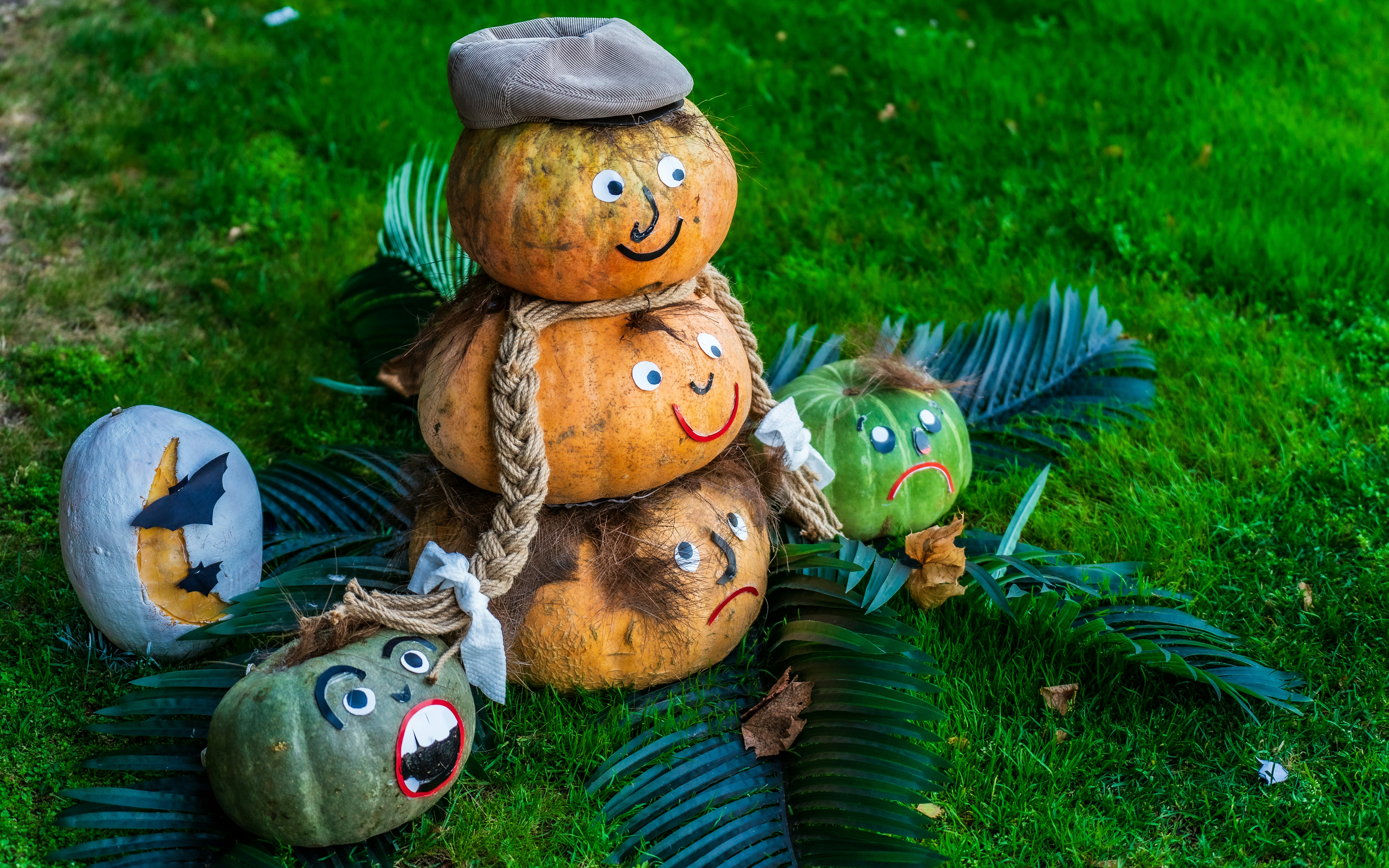 Pumpkin Stack with Grinning Faces on a Leafy Playground