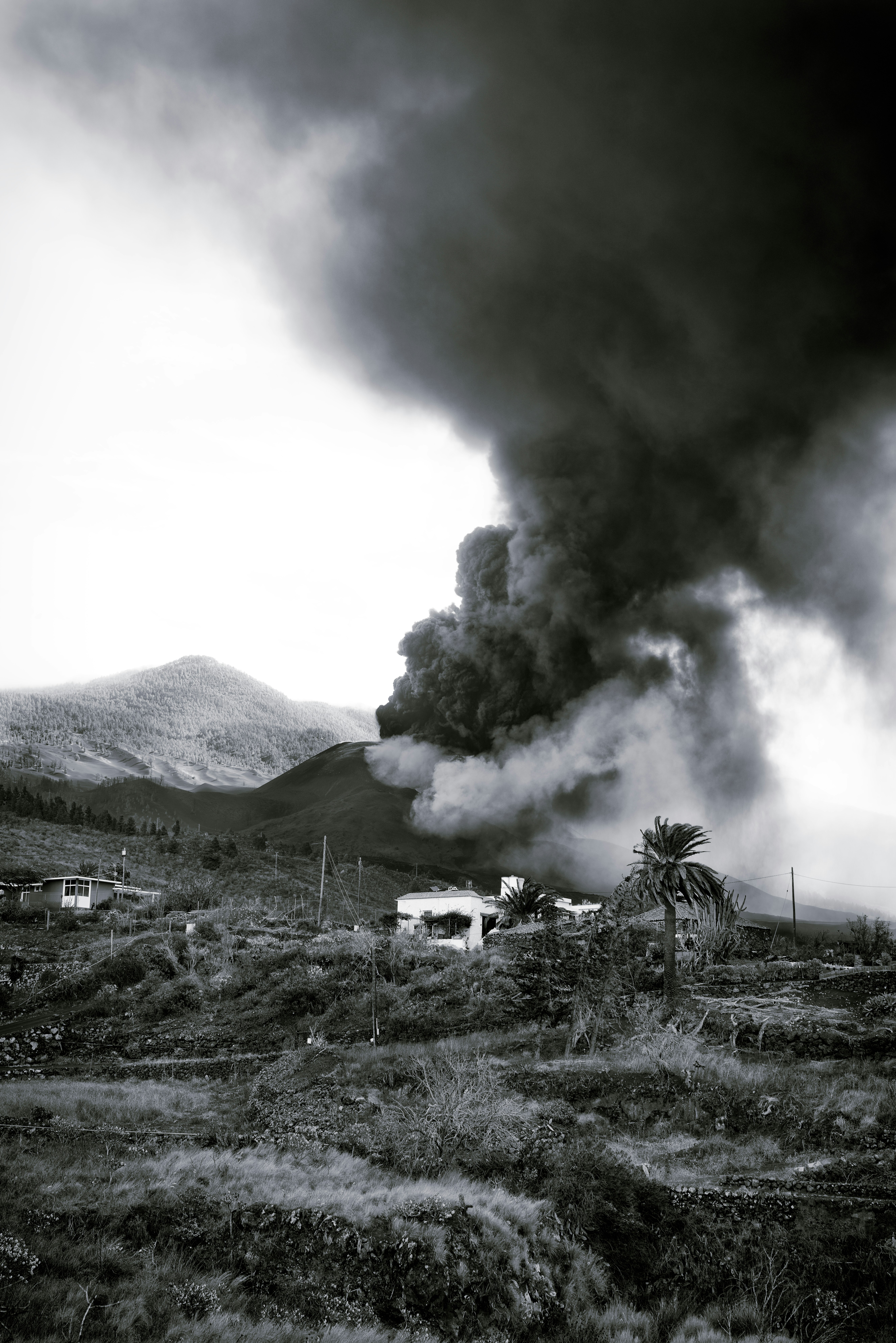 Ash Curtain Over a Quiet Highland Village