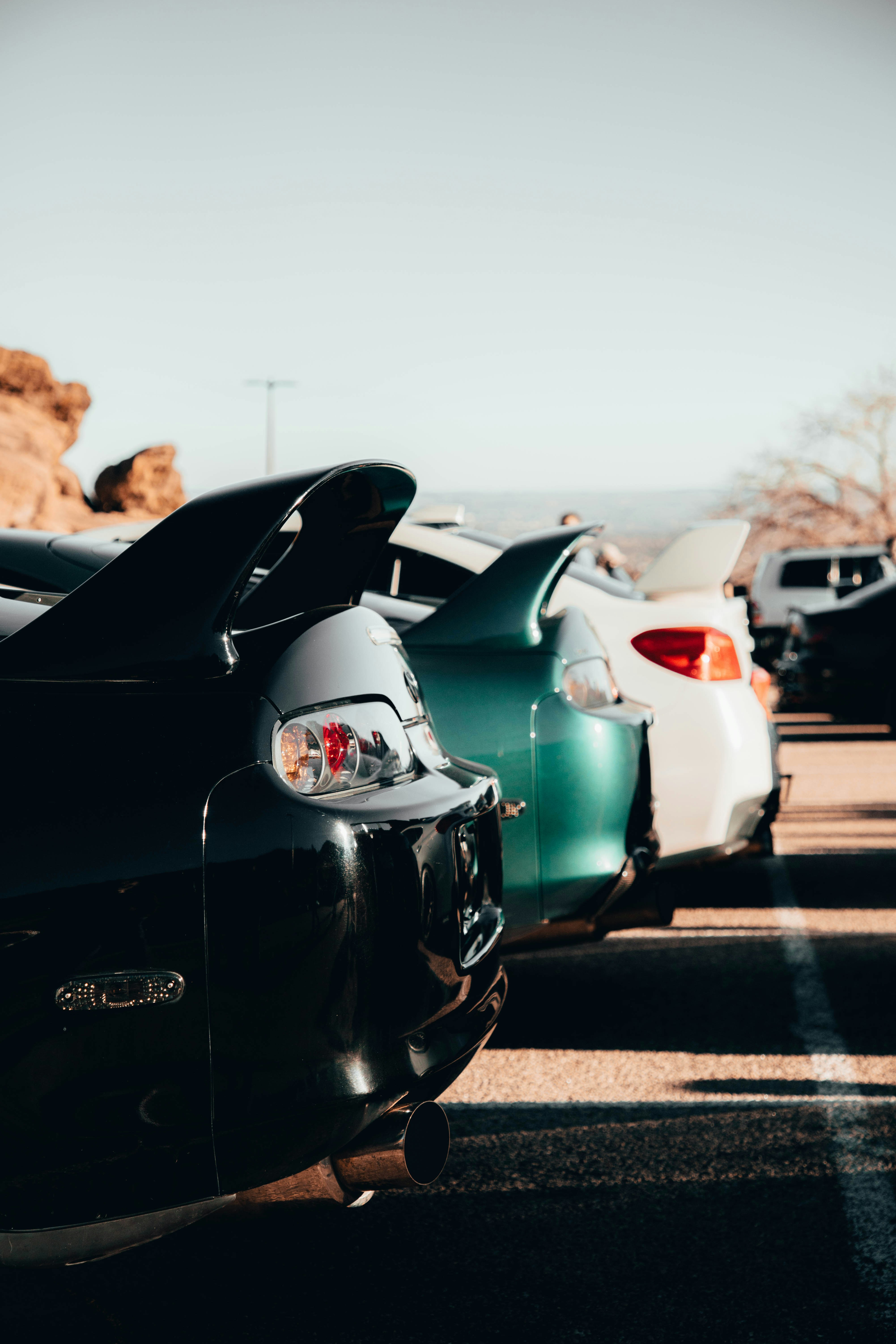 A row of parked cars sitting next to each other photo – Free Cars Image ...