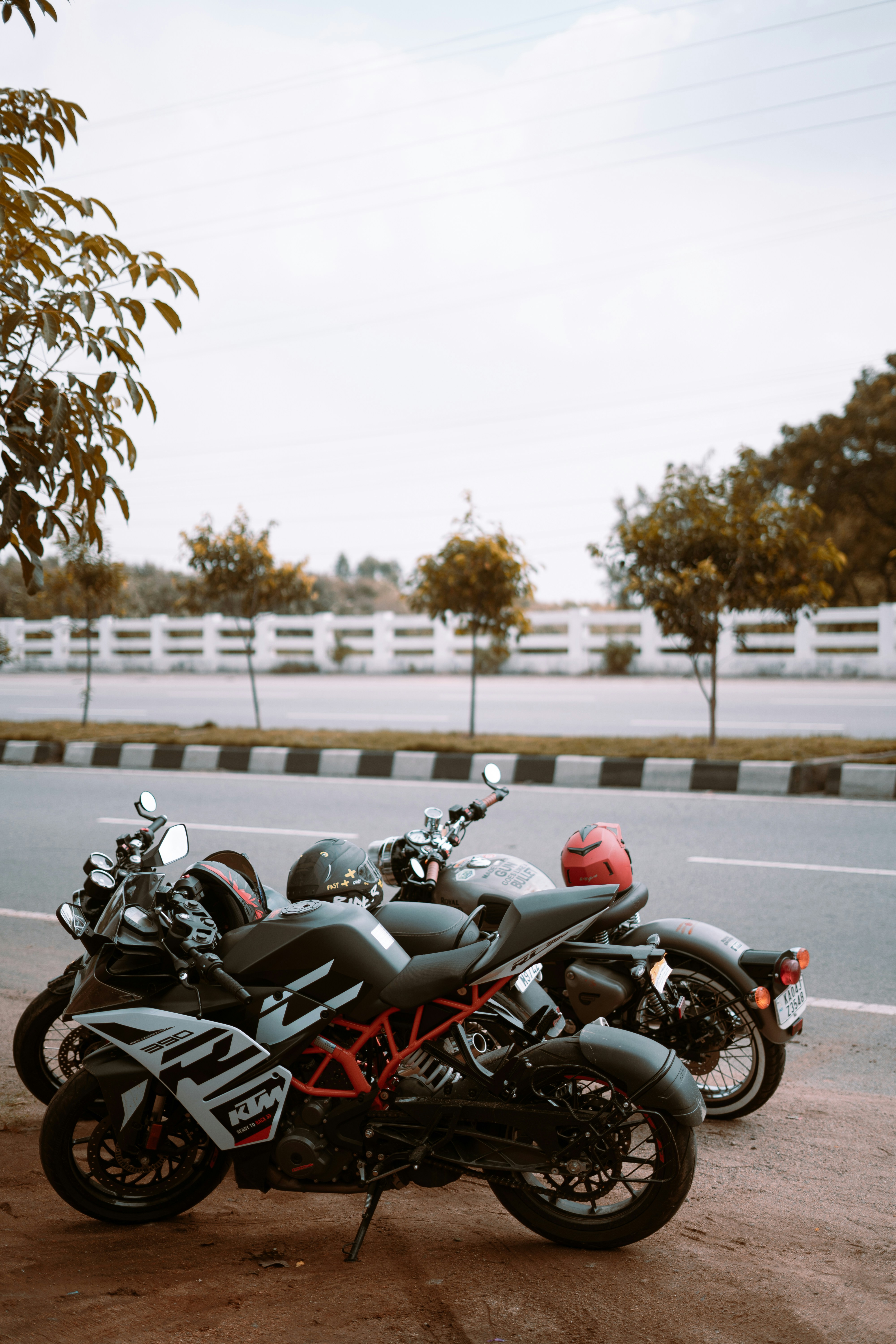 A couple of motorcycles parked on the side of the road photo – Free ...