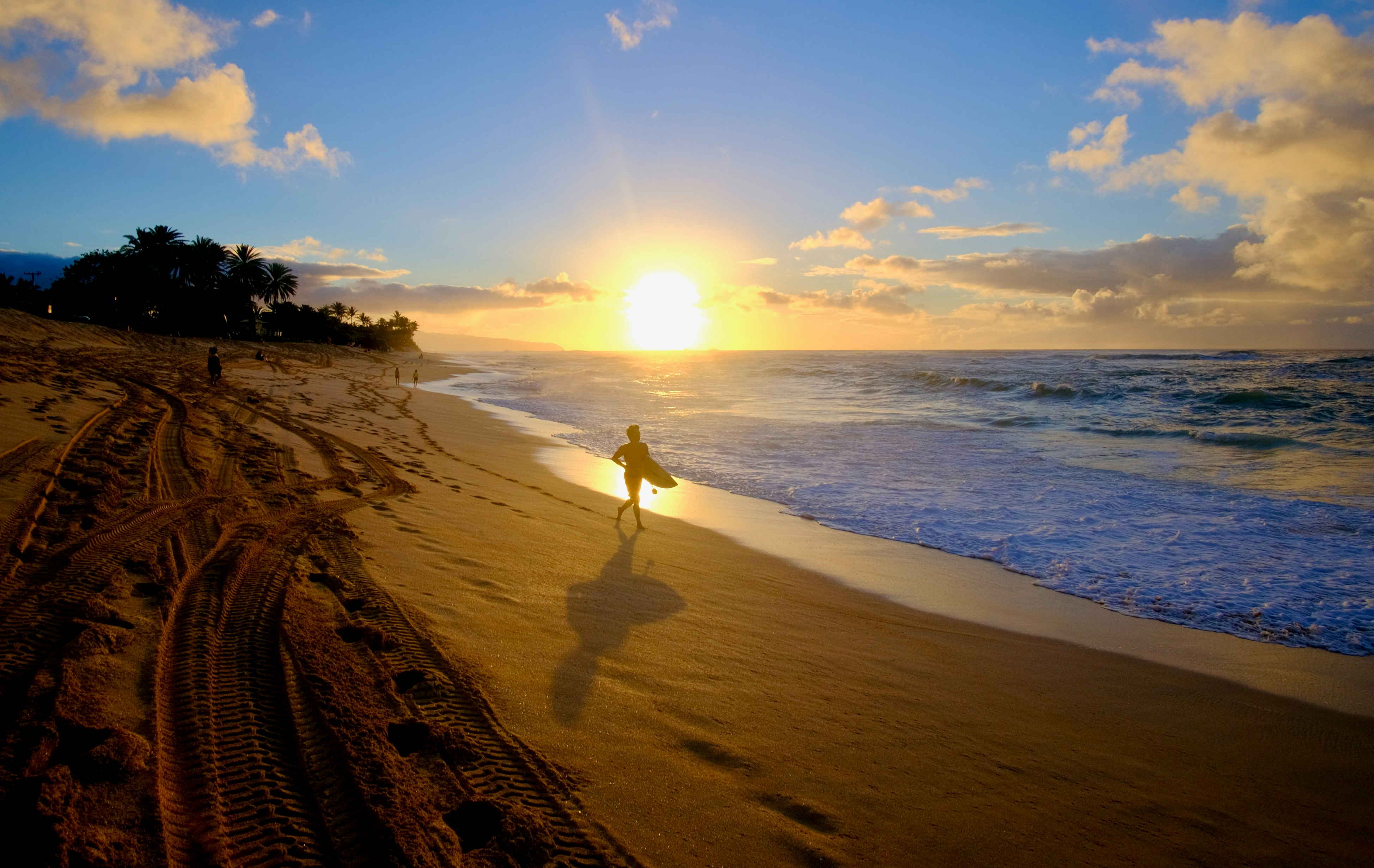 a person with a surfboard is walking on the beach