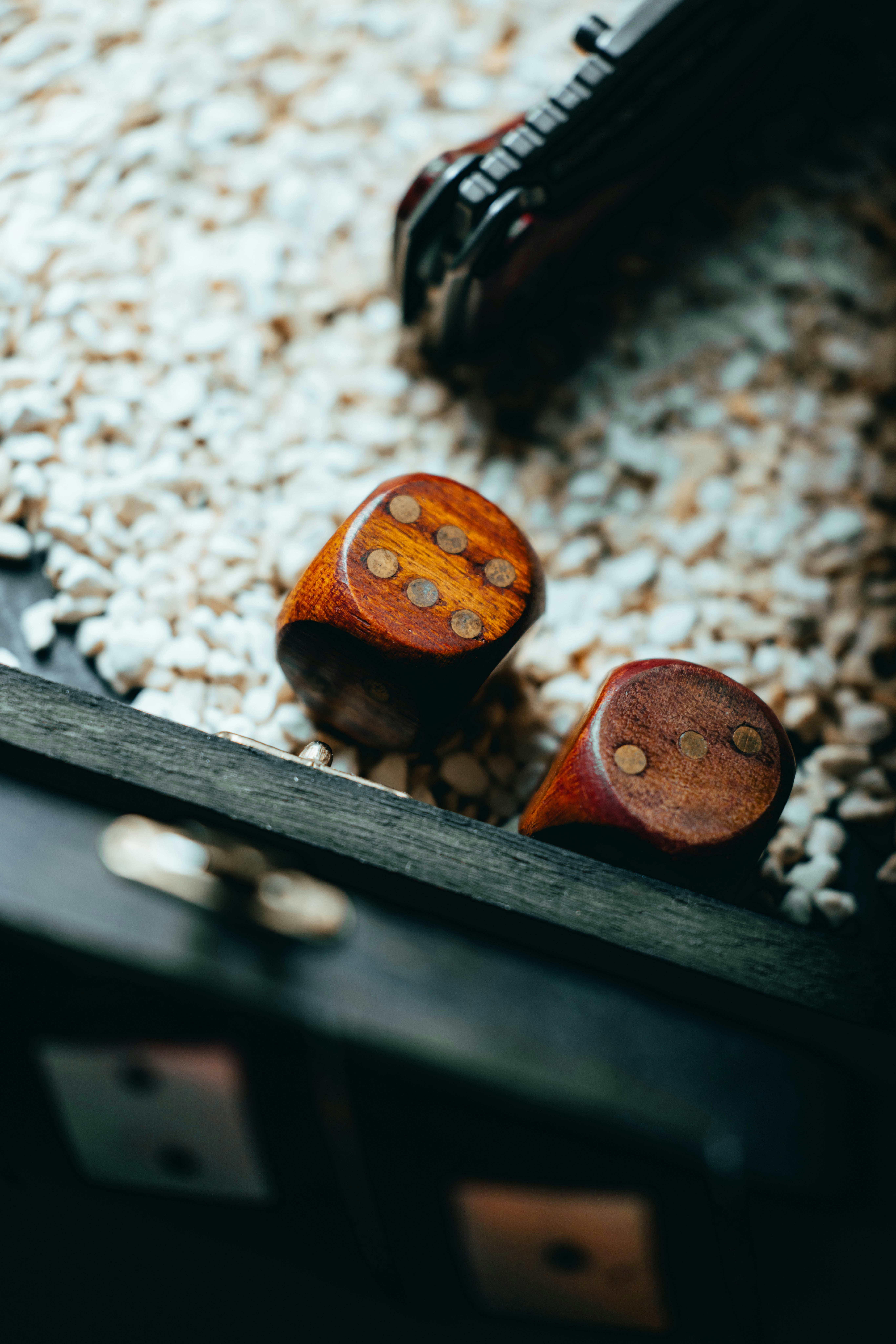 A couple of wooden dices sitting on top of a table photo – Free Dice ...