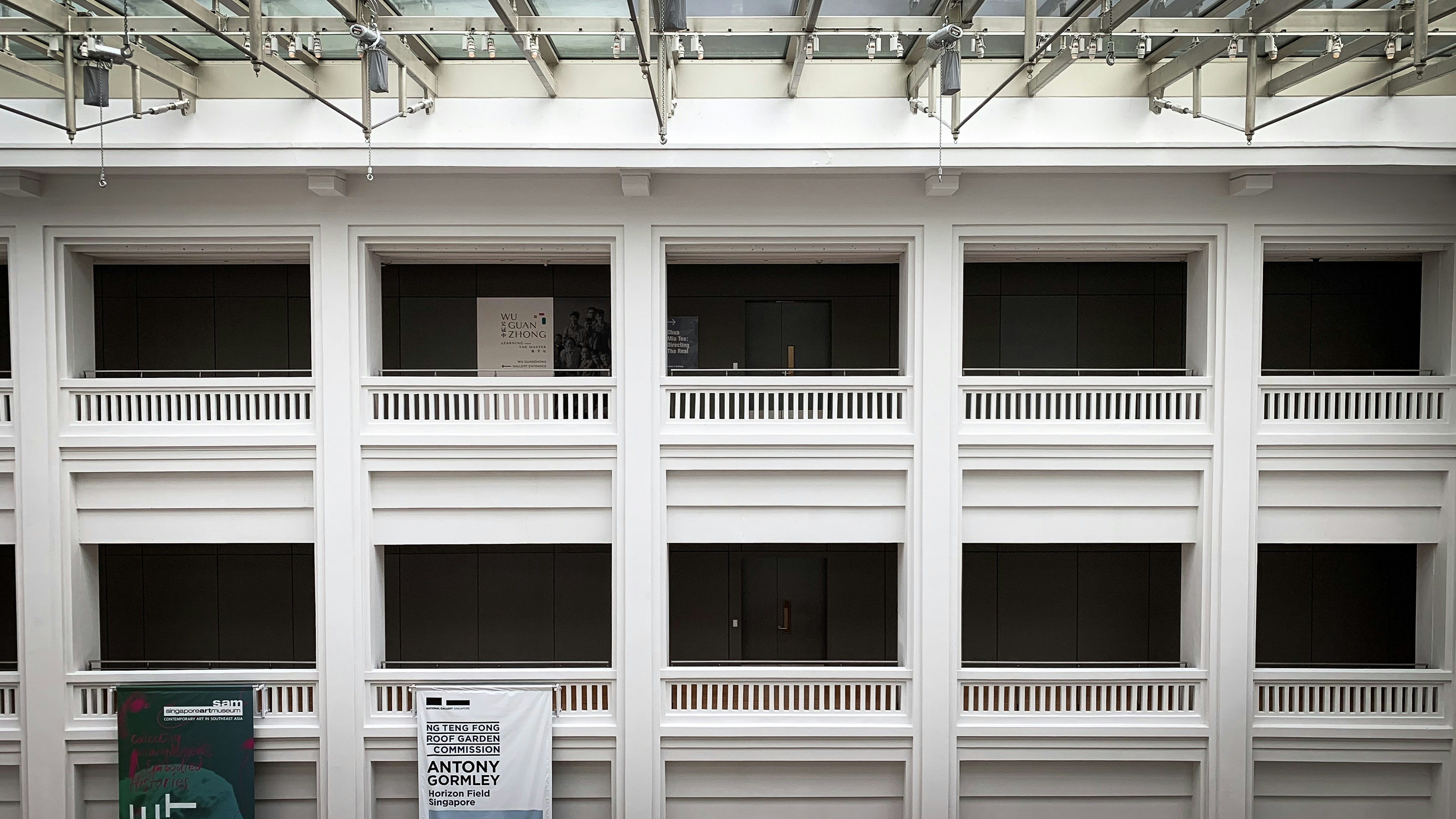 Interior landscape view of National Gallery Singapore. | a parking meter sitting in front of a tall building