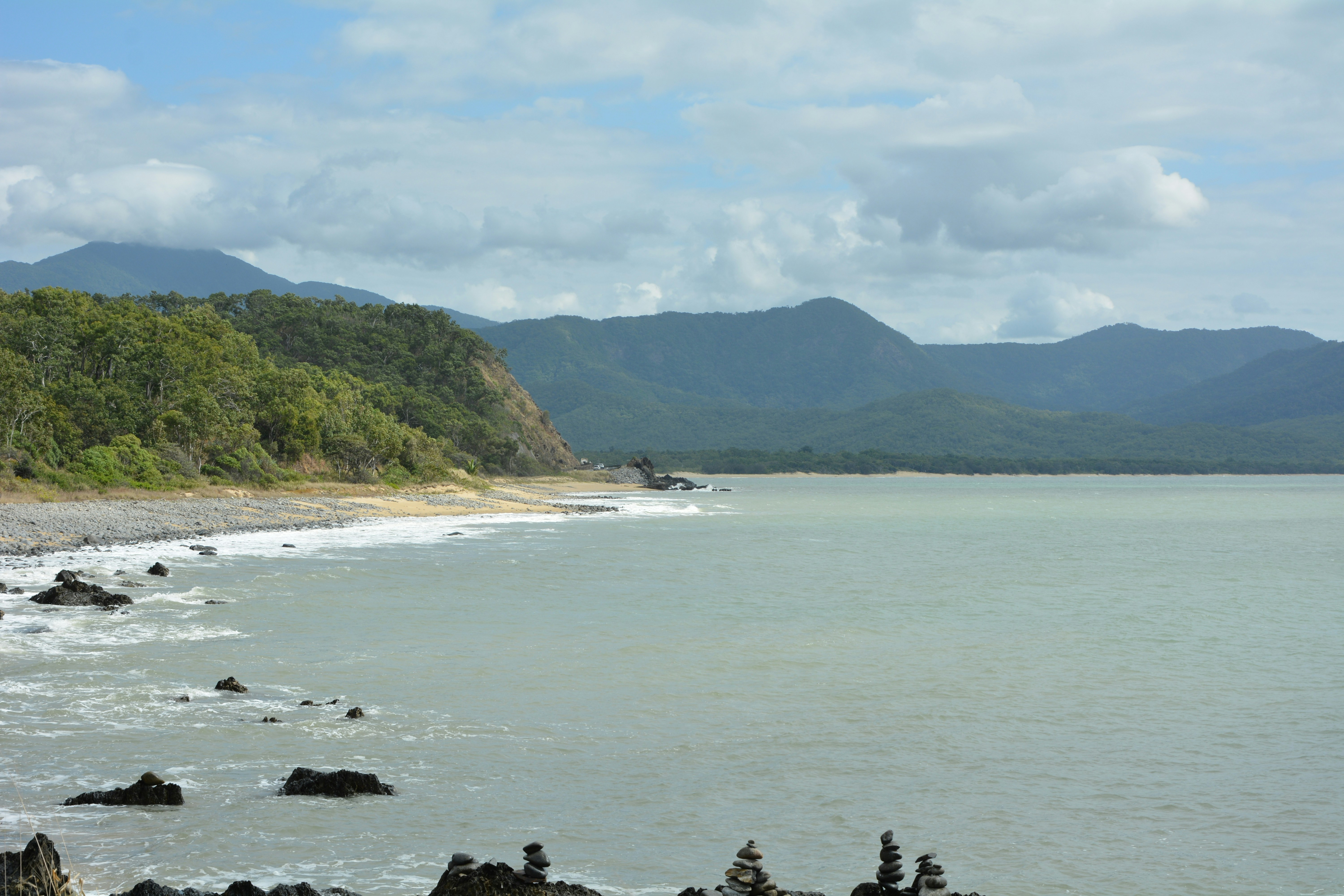 a body of water surrounded by mountains and trees