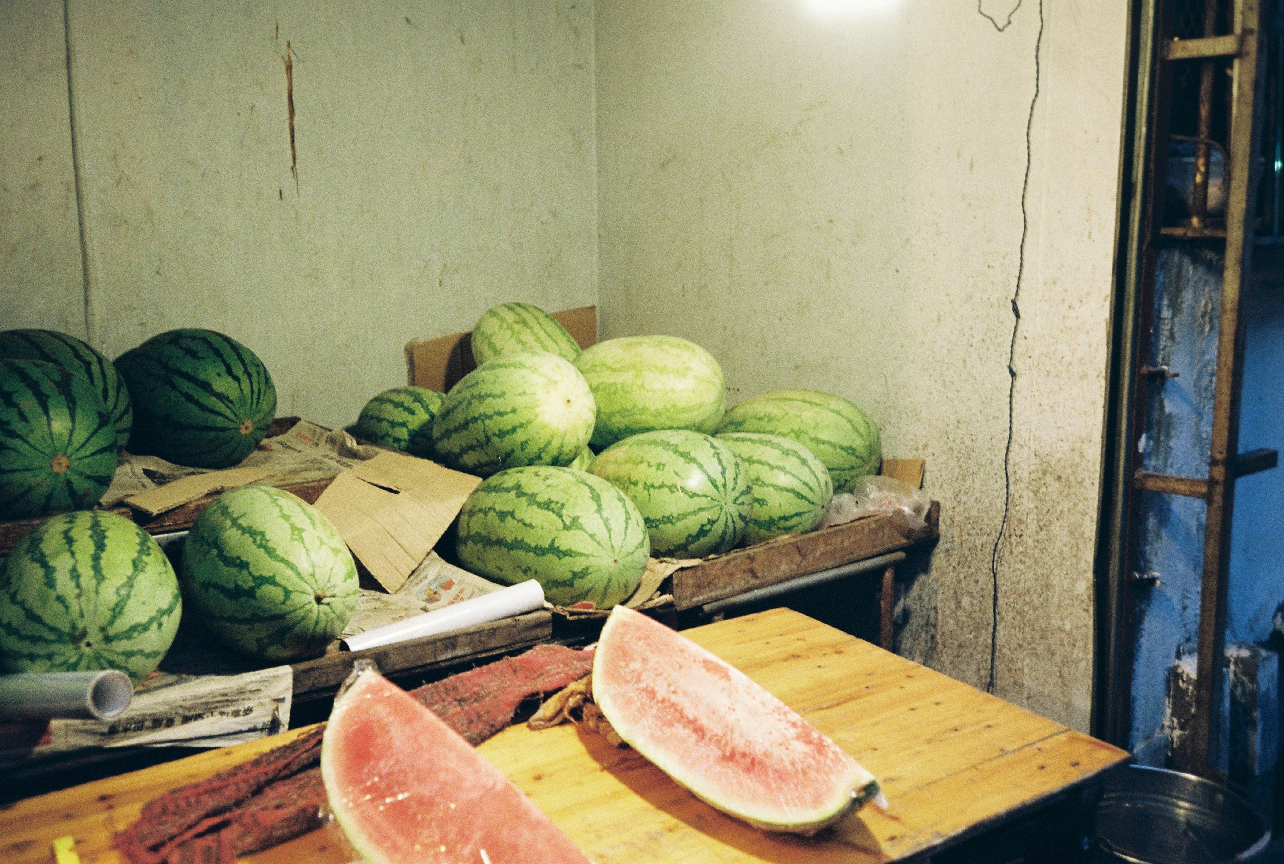 A bunch of watermelons sitting on top of a wooden table photo – Free ...